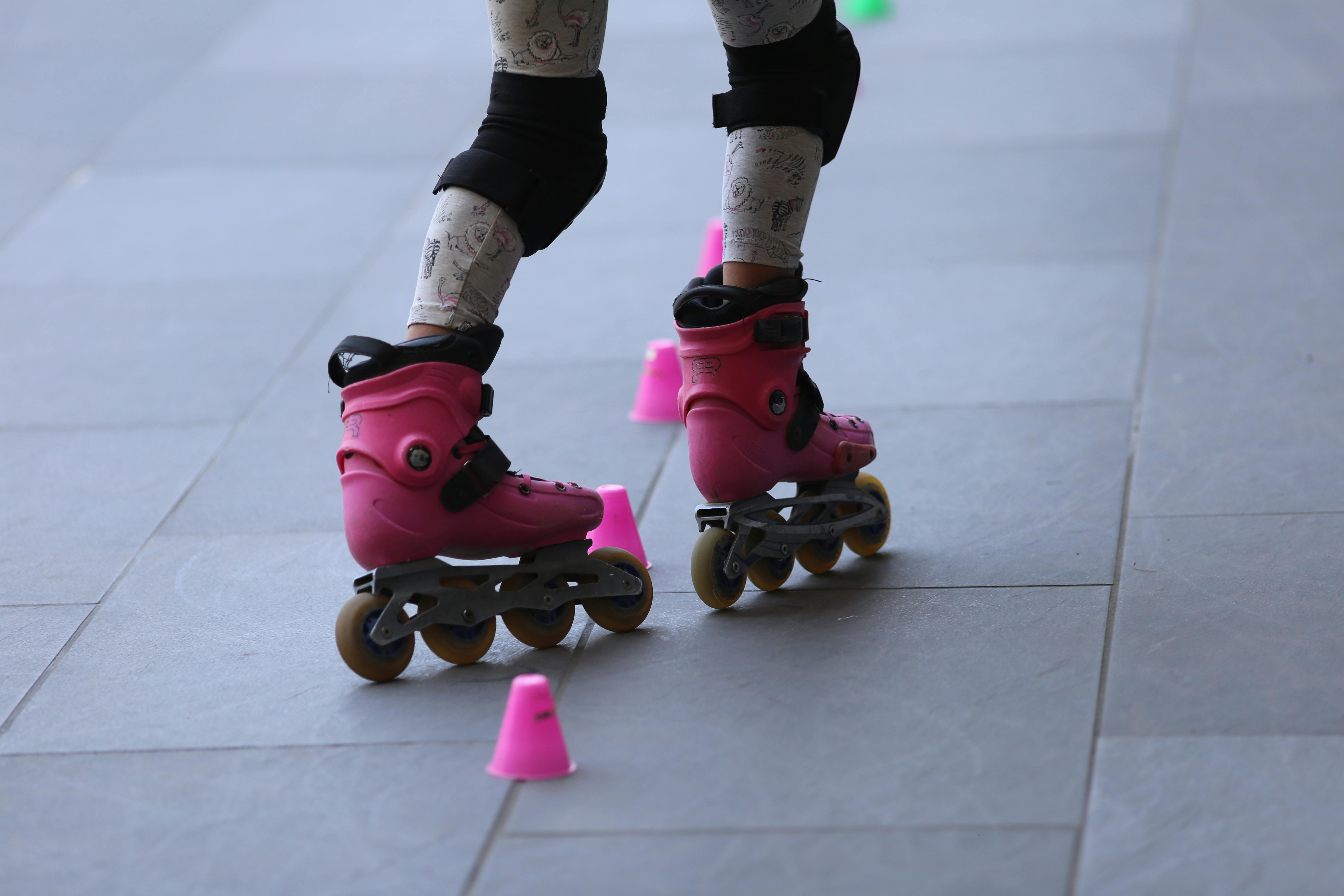 Child Skating with Pink Rollerblades Outdoors · Free Stock Photo