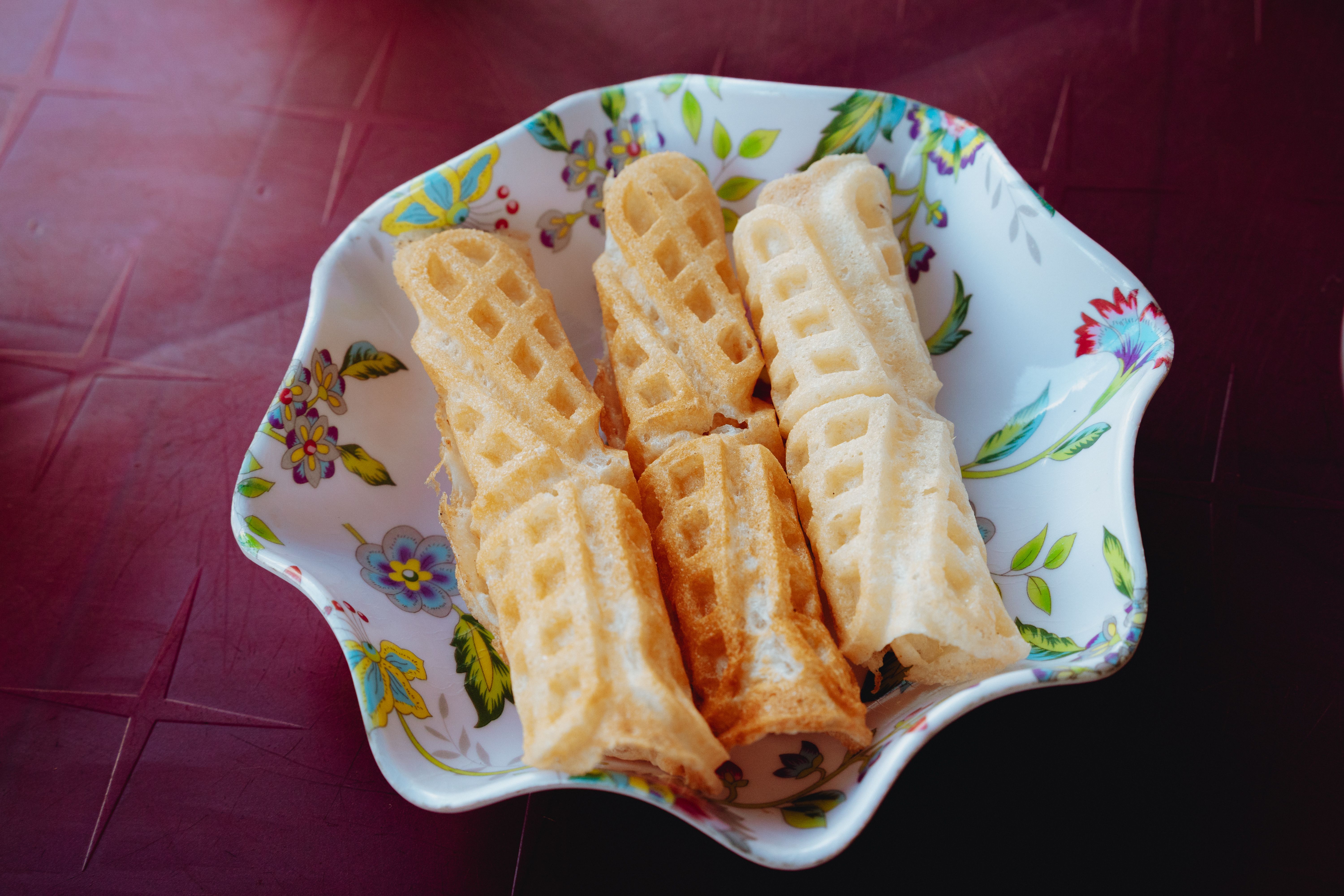 Delicious Waffle Rolls in Floral Bowl on Table · Free Stock Photo