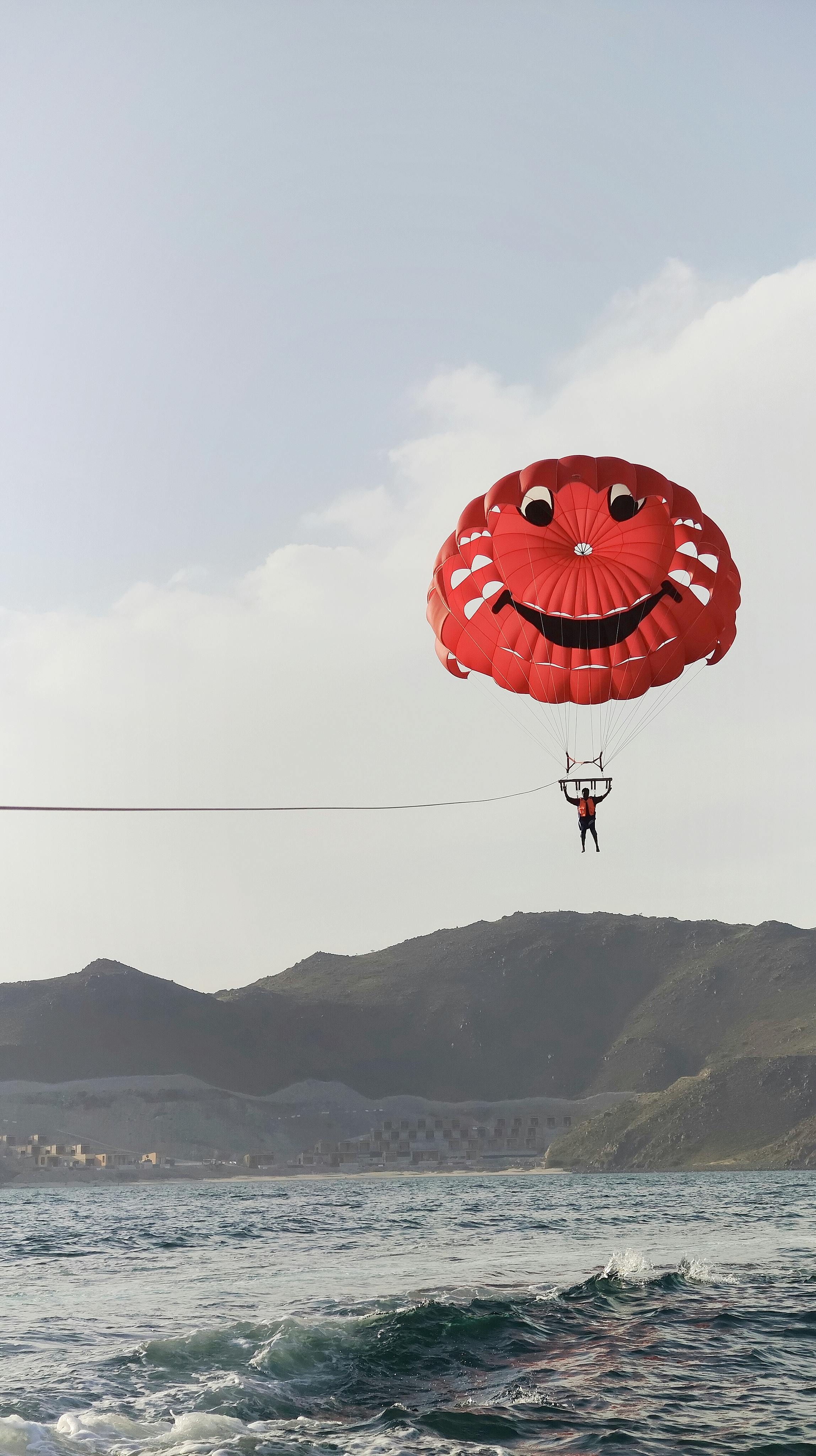 Parasailing Adventure with Smiley Parachute in Fujairah · Free Stock Photo