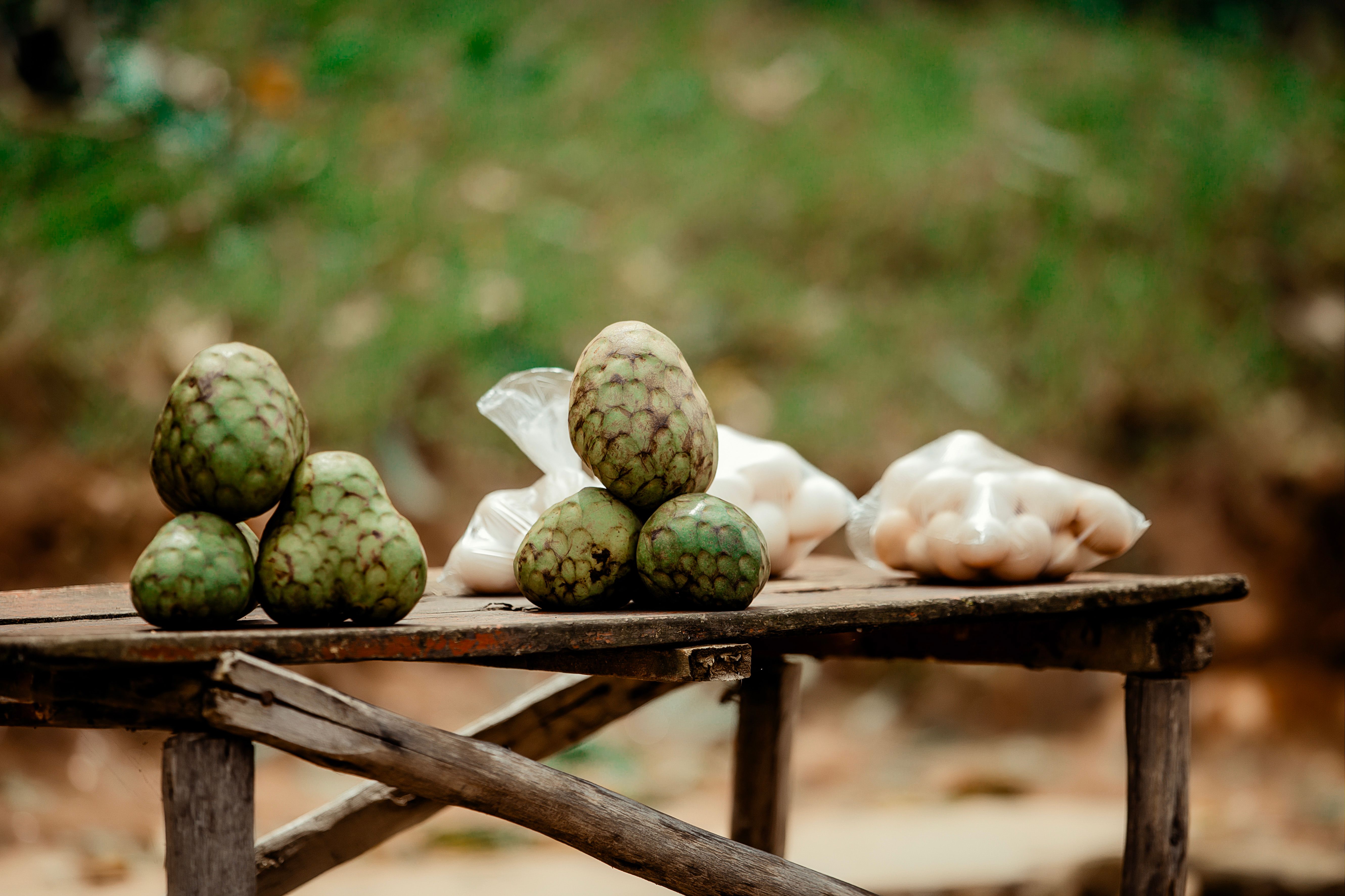 Fresh Cherimoya Fruits on Rustic Outdoor Table · Free Stock Photo