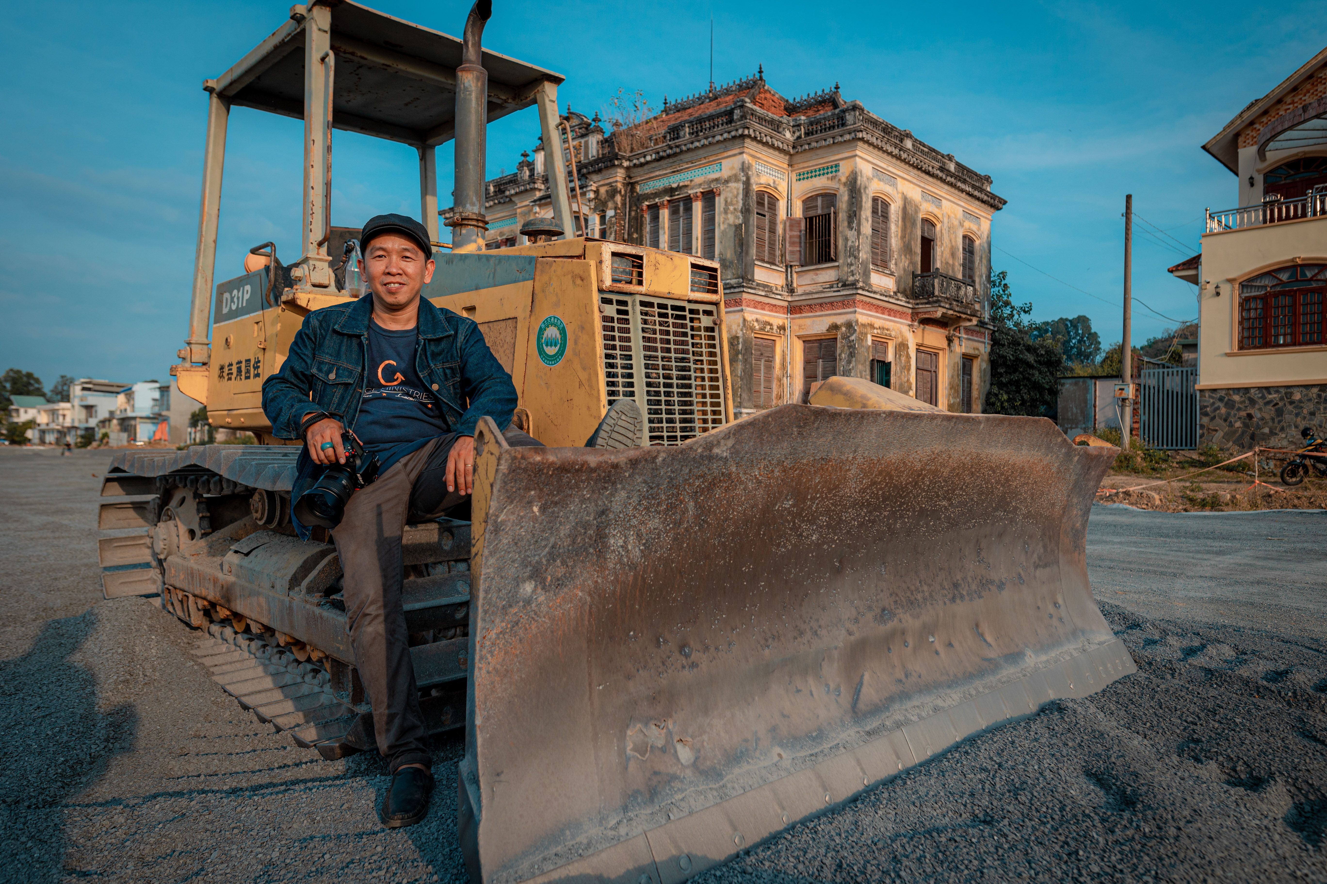 Man Relaxing on Bulldozer in Bien Hoa, Vietnam · Free Stock Photo