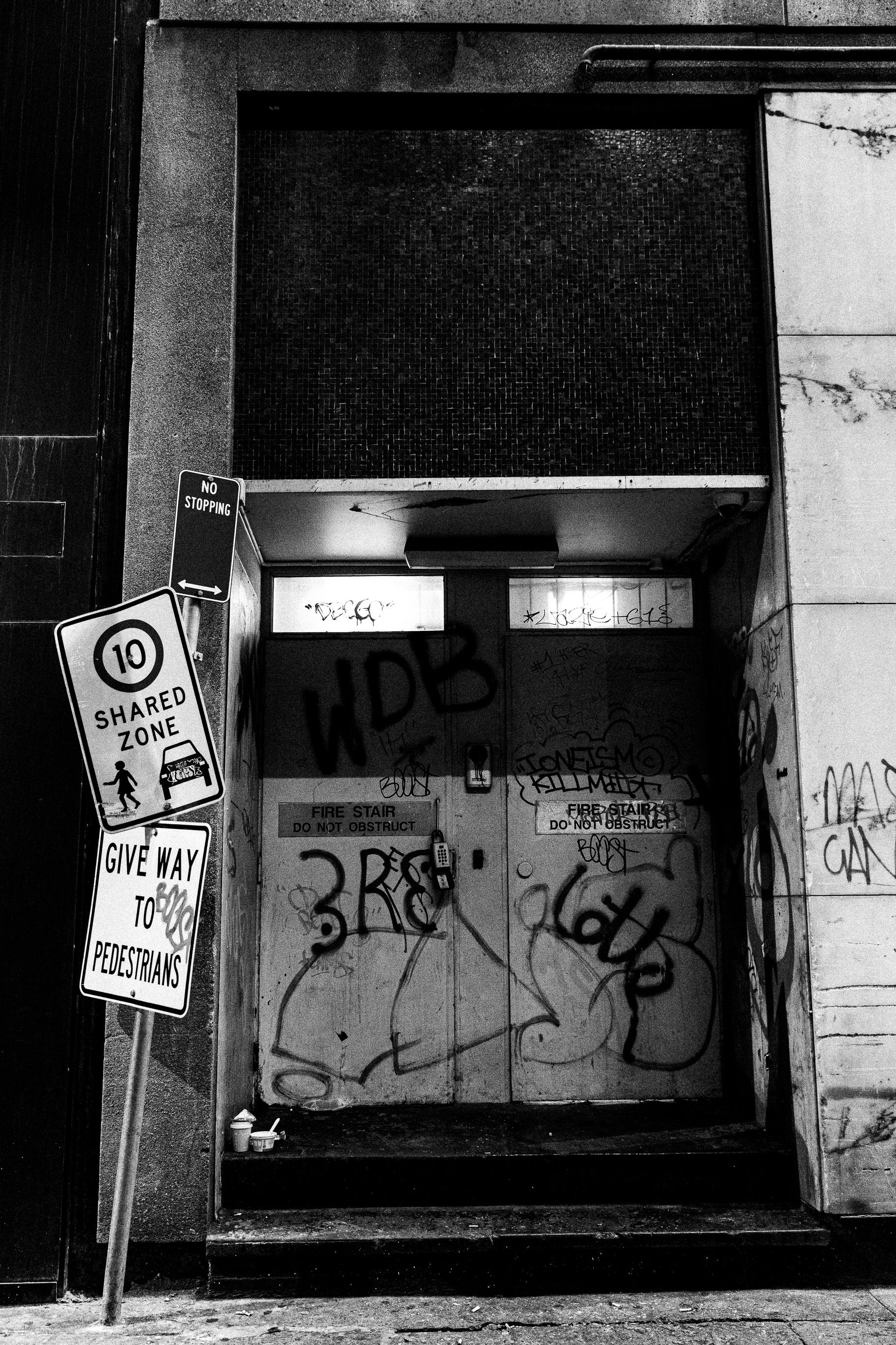Urban Alleyway with Graffiti and Signage in Black and White · Free ...