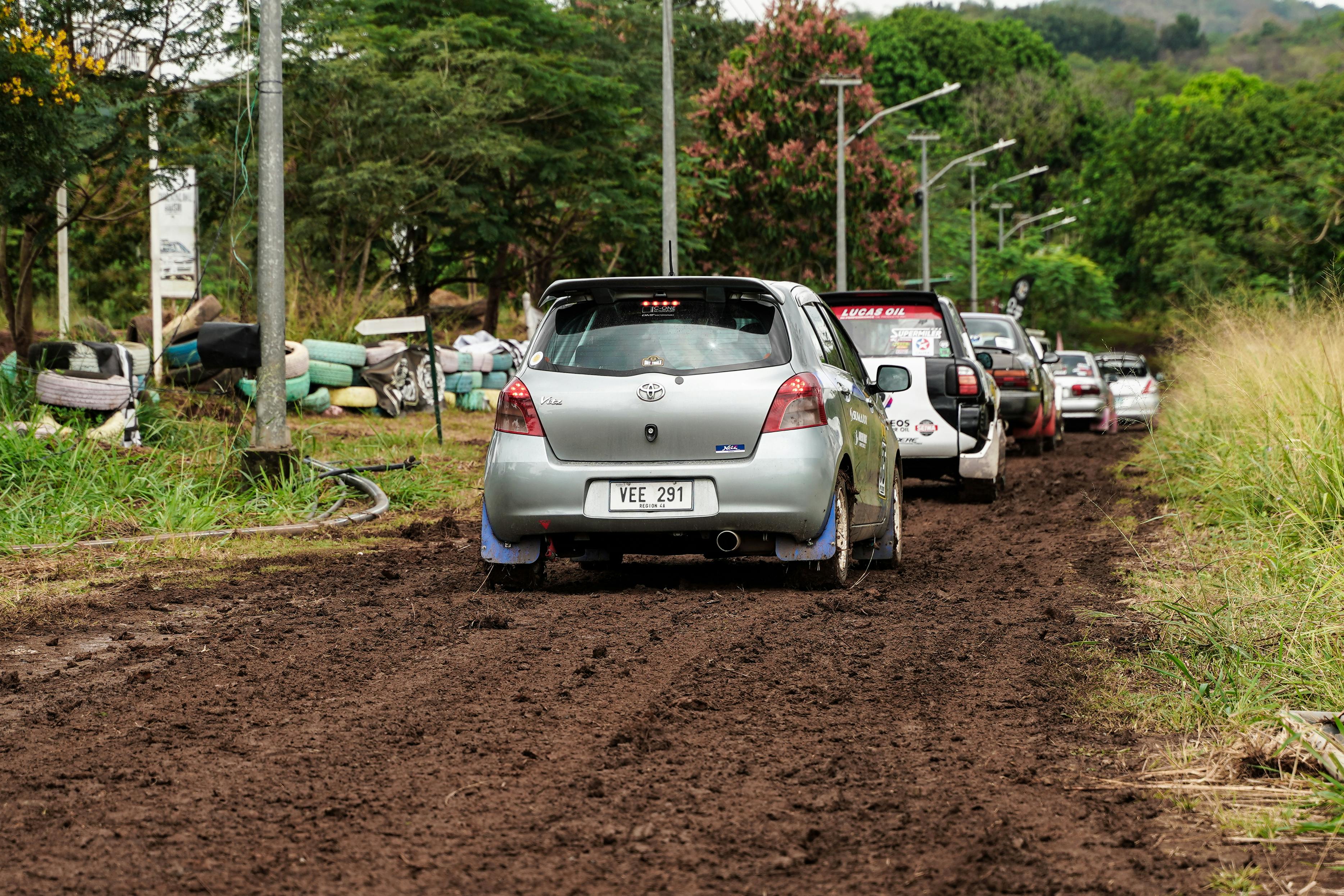 Cars driving on muddy road in Baras, Philippines · Free Stock Photo