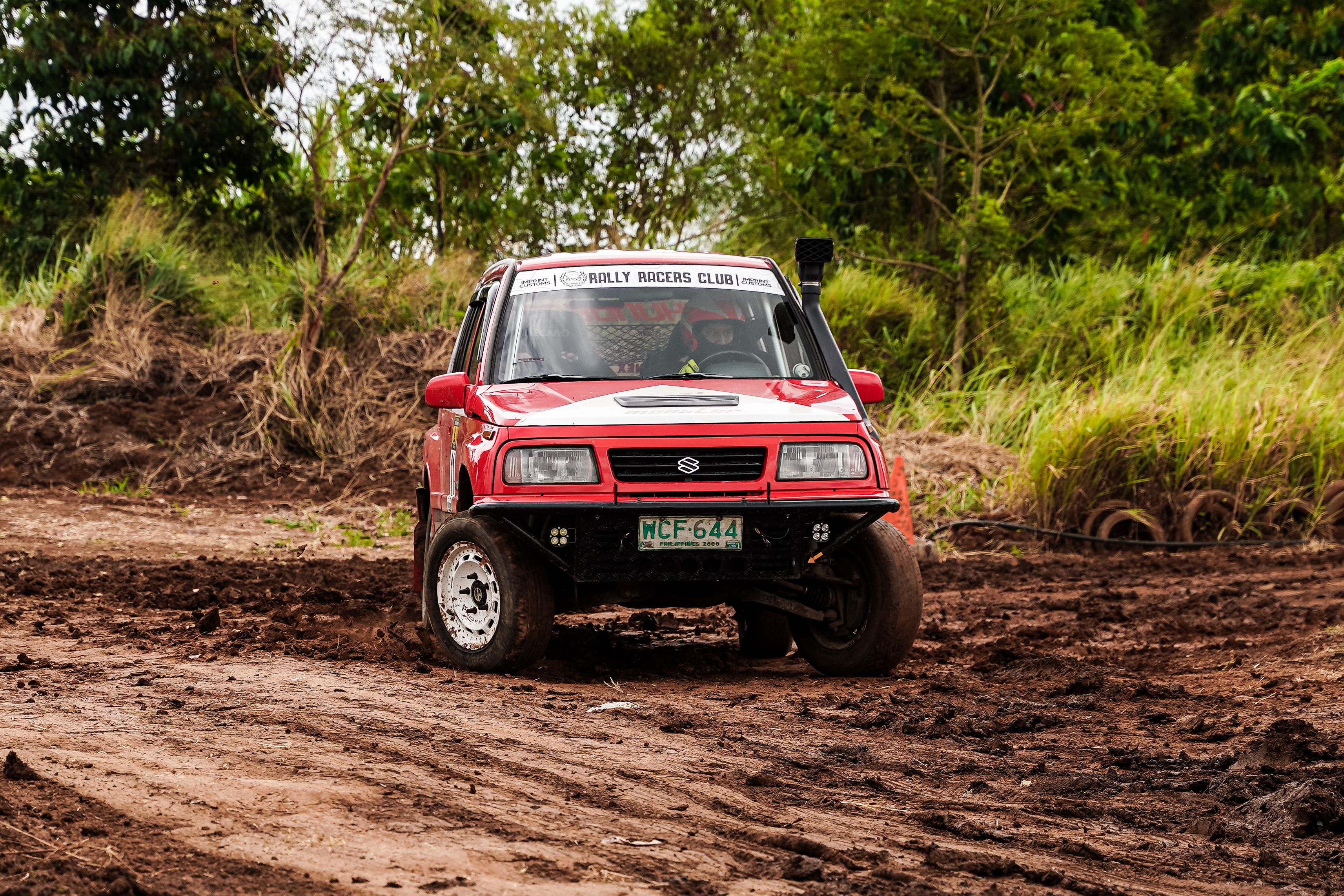 Red Suzuki SUV in Off-Road Rally Action · Free Stock Photo