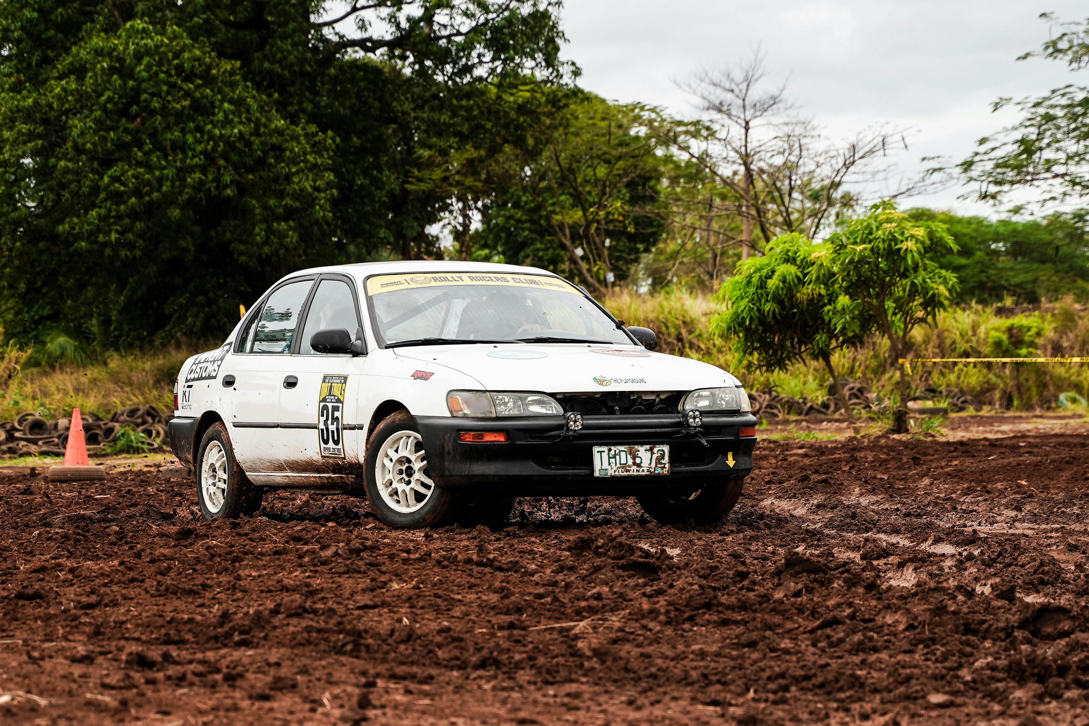 Dynamic Rally Car Racing on Muddy Terrain · Free Stock Photo