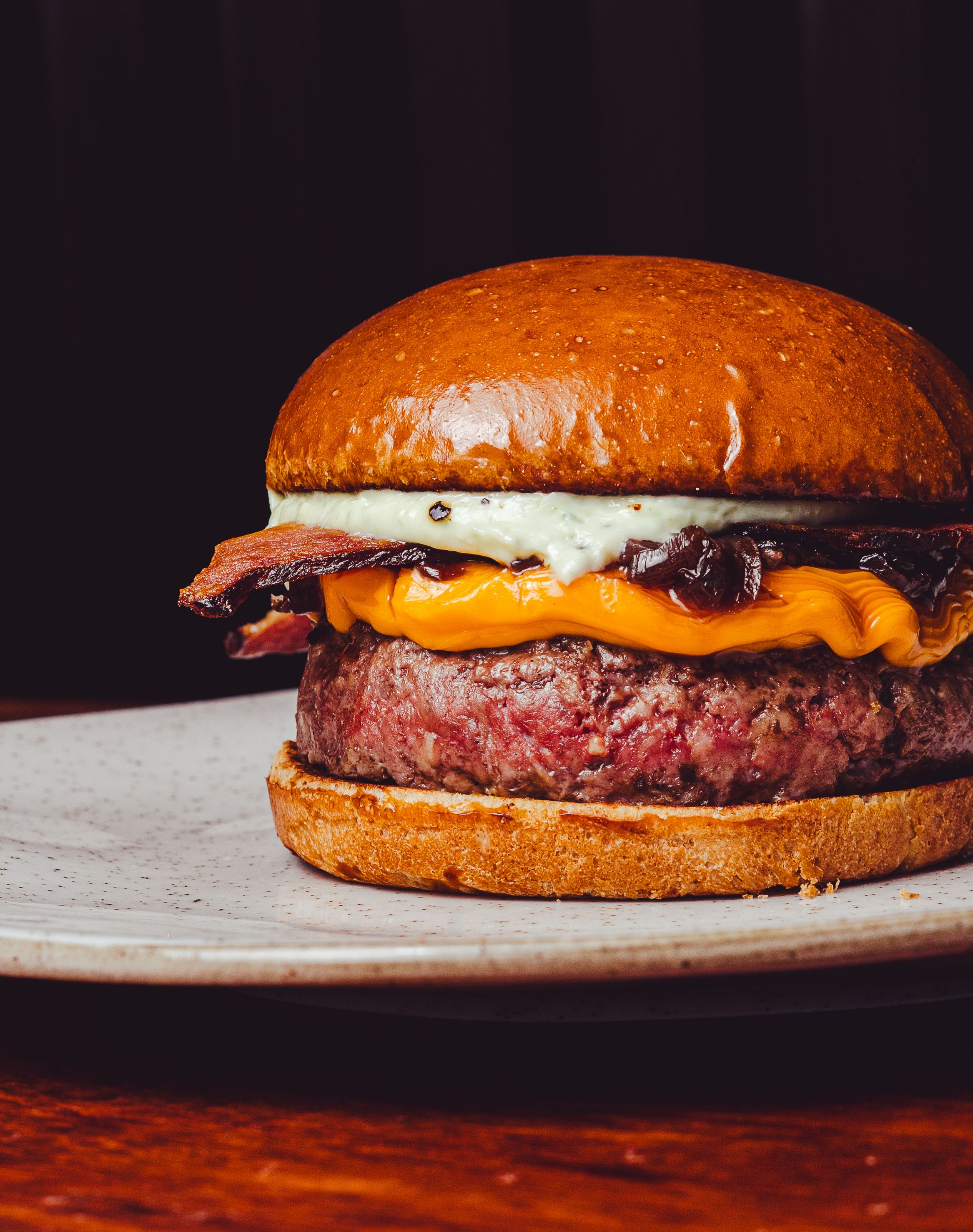 Delicious Gourmet Cheeseburger on Plate · Free Stock Photo