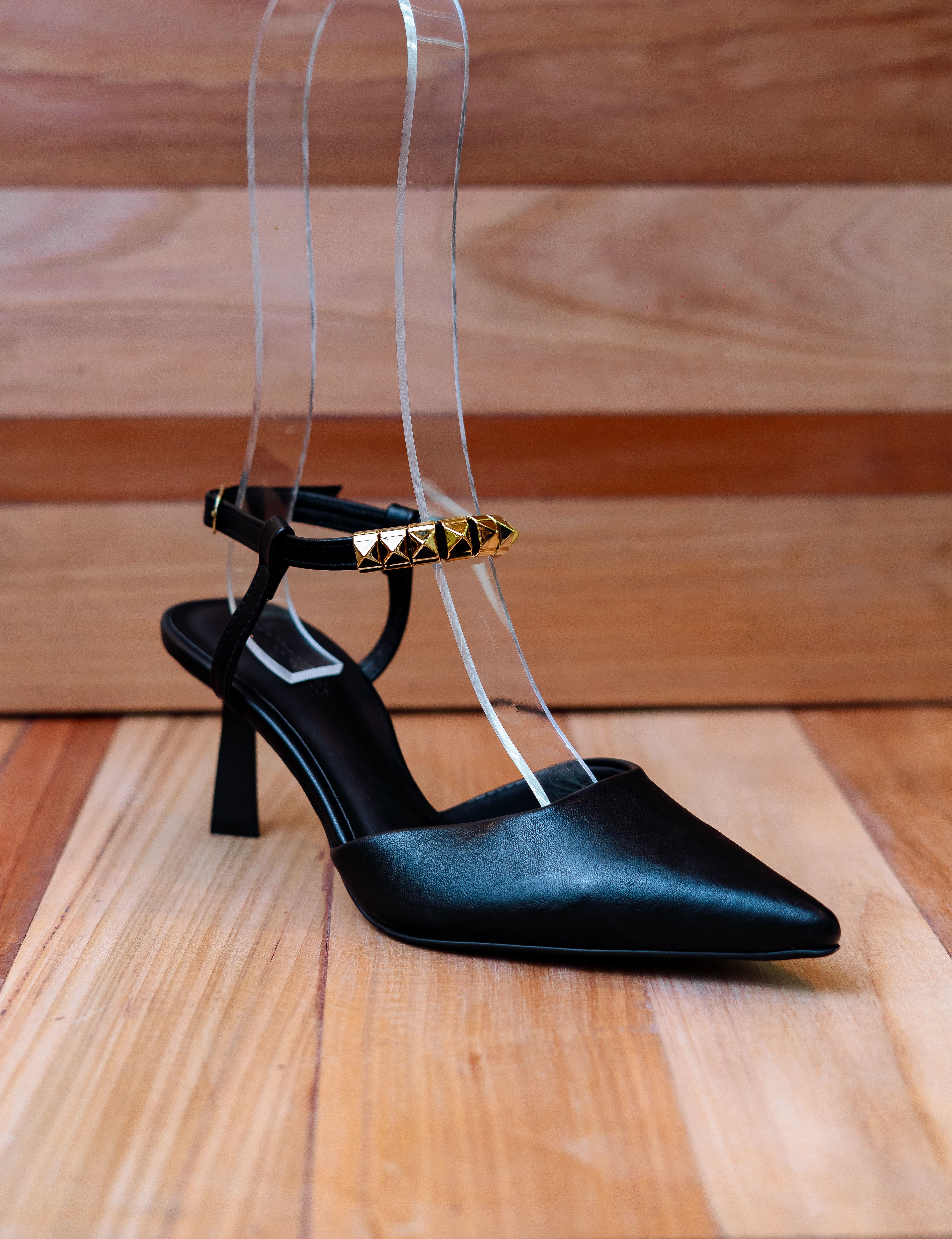 Elegant Black High Heel Shoe Display on Wooden Floor · Free Stock Photo
