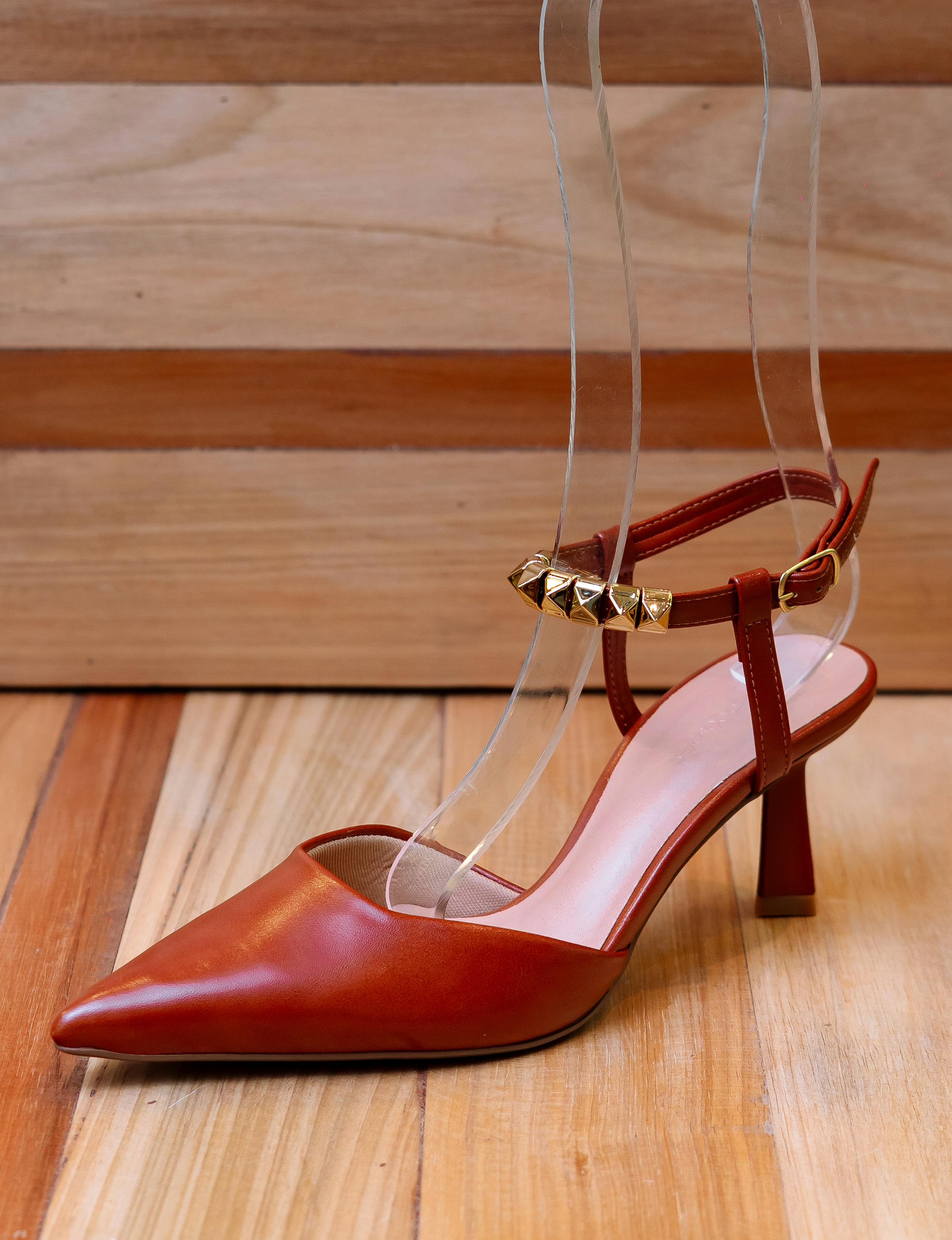 Elegant Brown Leather Stiletto Heel Display · Free Stock Photo