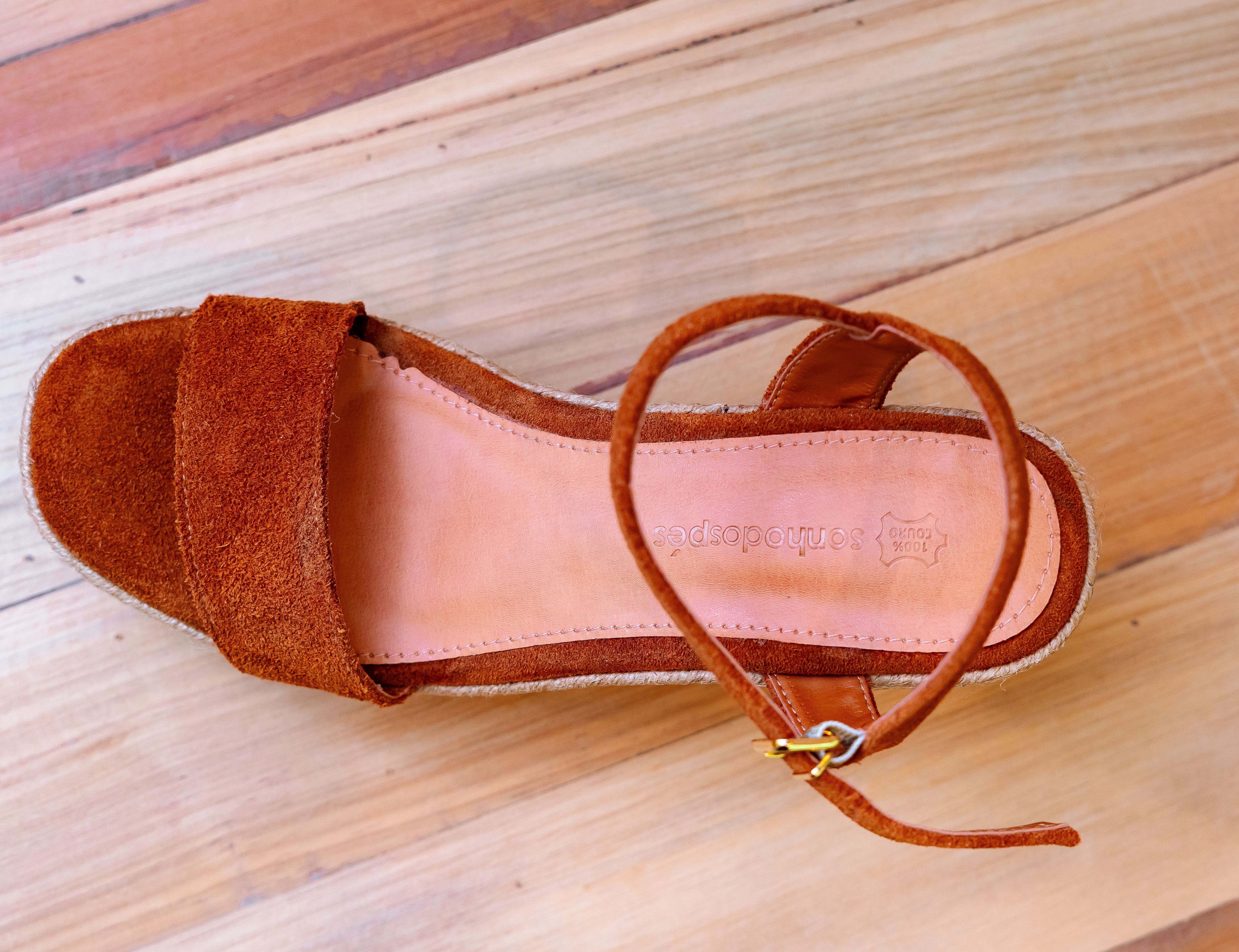 Brown Suede Sandal on Wooden Floor · Free Stock Photo