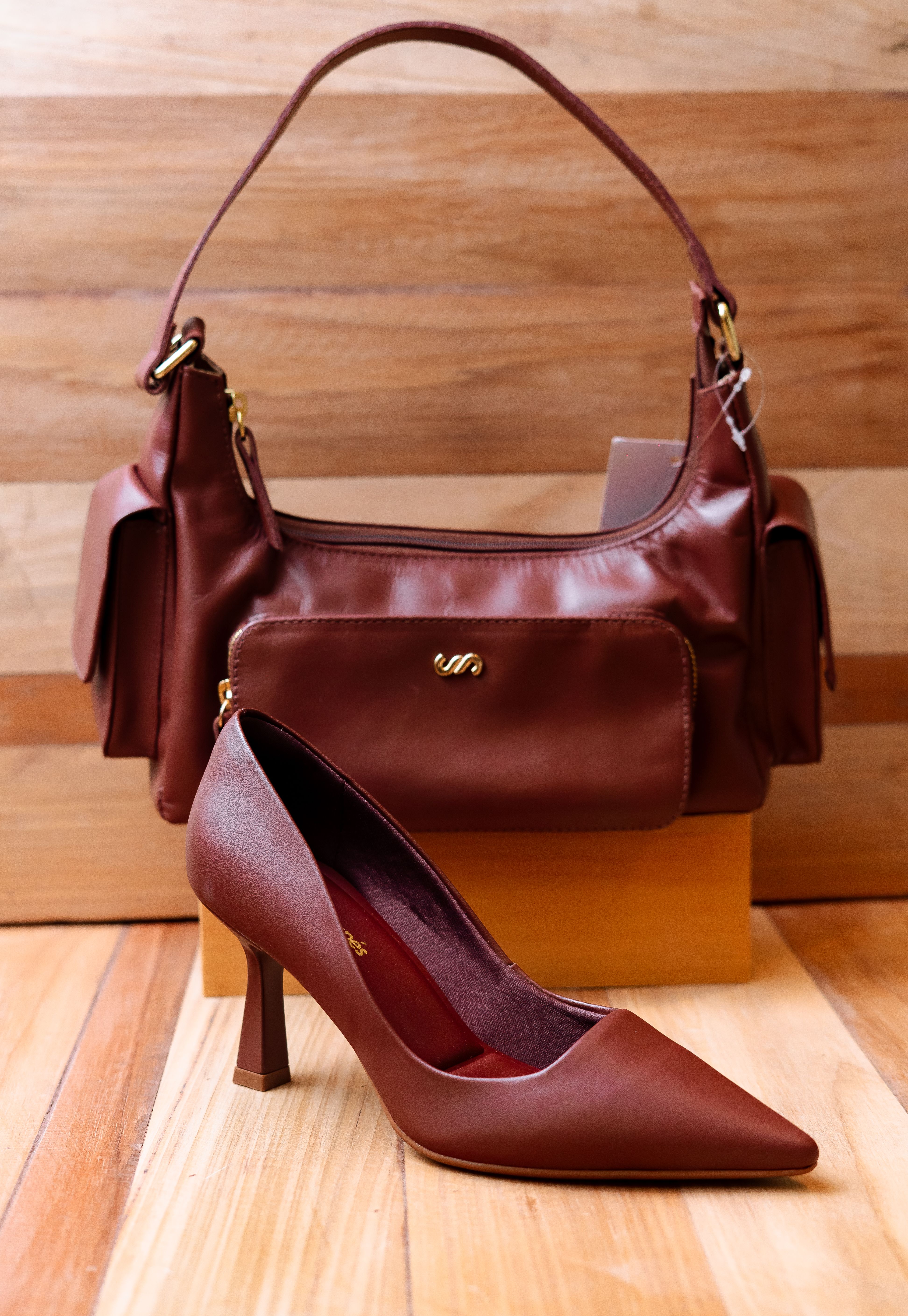 Elegant Brown Handbag and Heels on Wooden Surface · Free Stock Photo