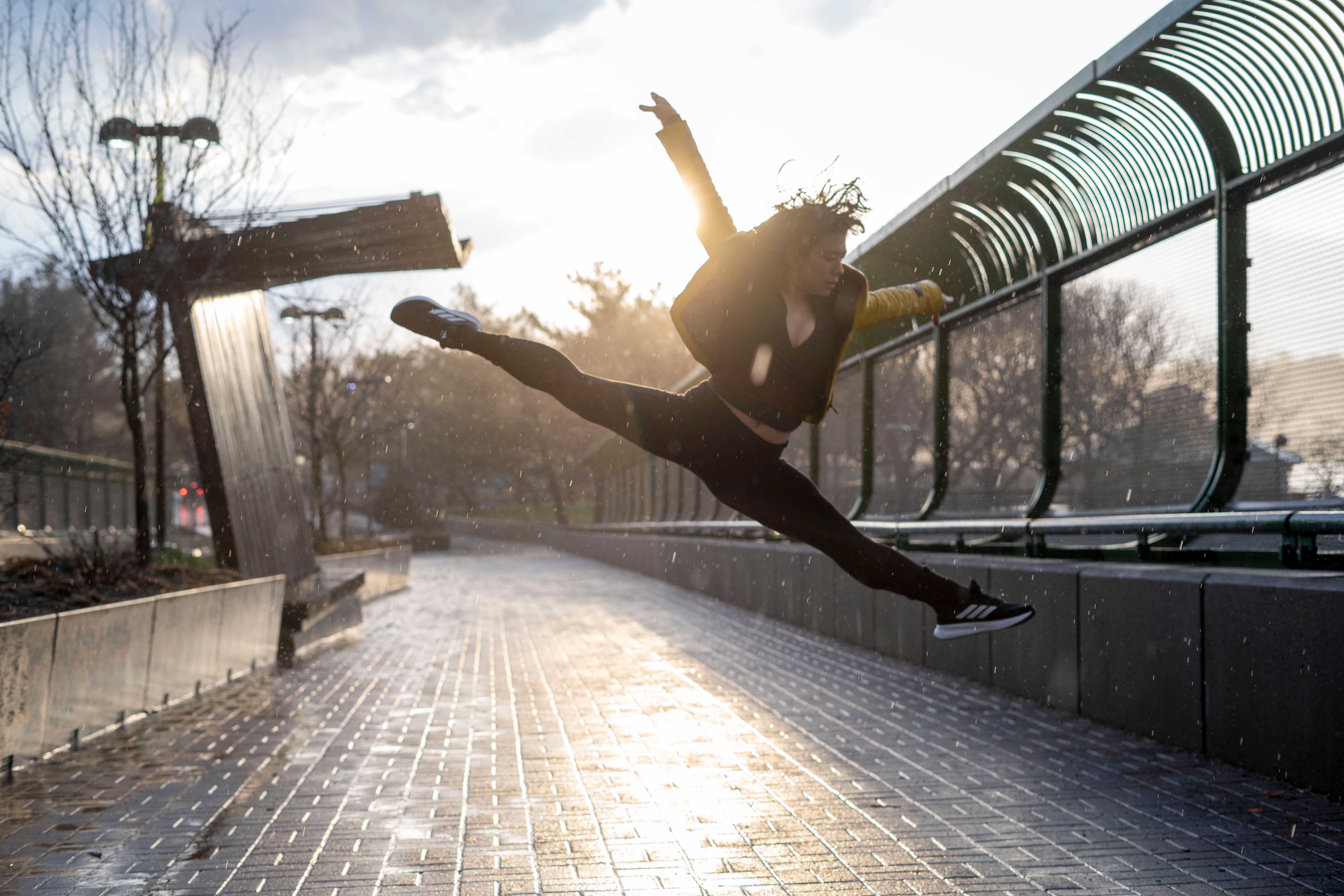 Dynamic Outdoor Dance Leap in the Rain · Free Stock Photo
