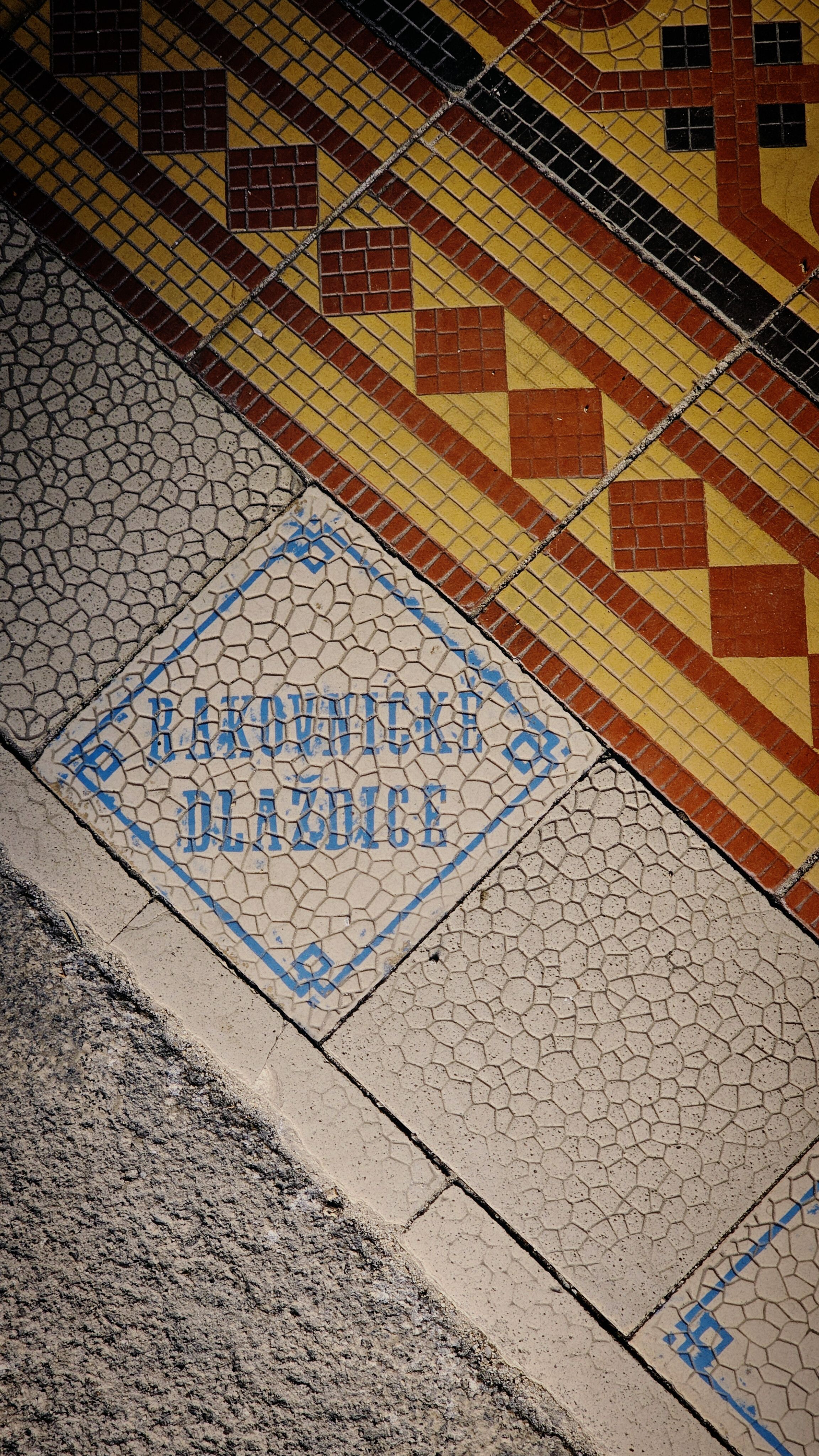 Intricate Geometric Mosaic Tiles on Pavement · Free Stock Photo