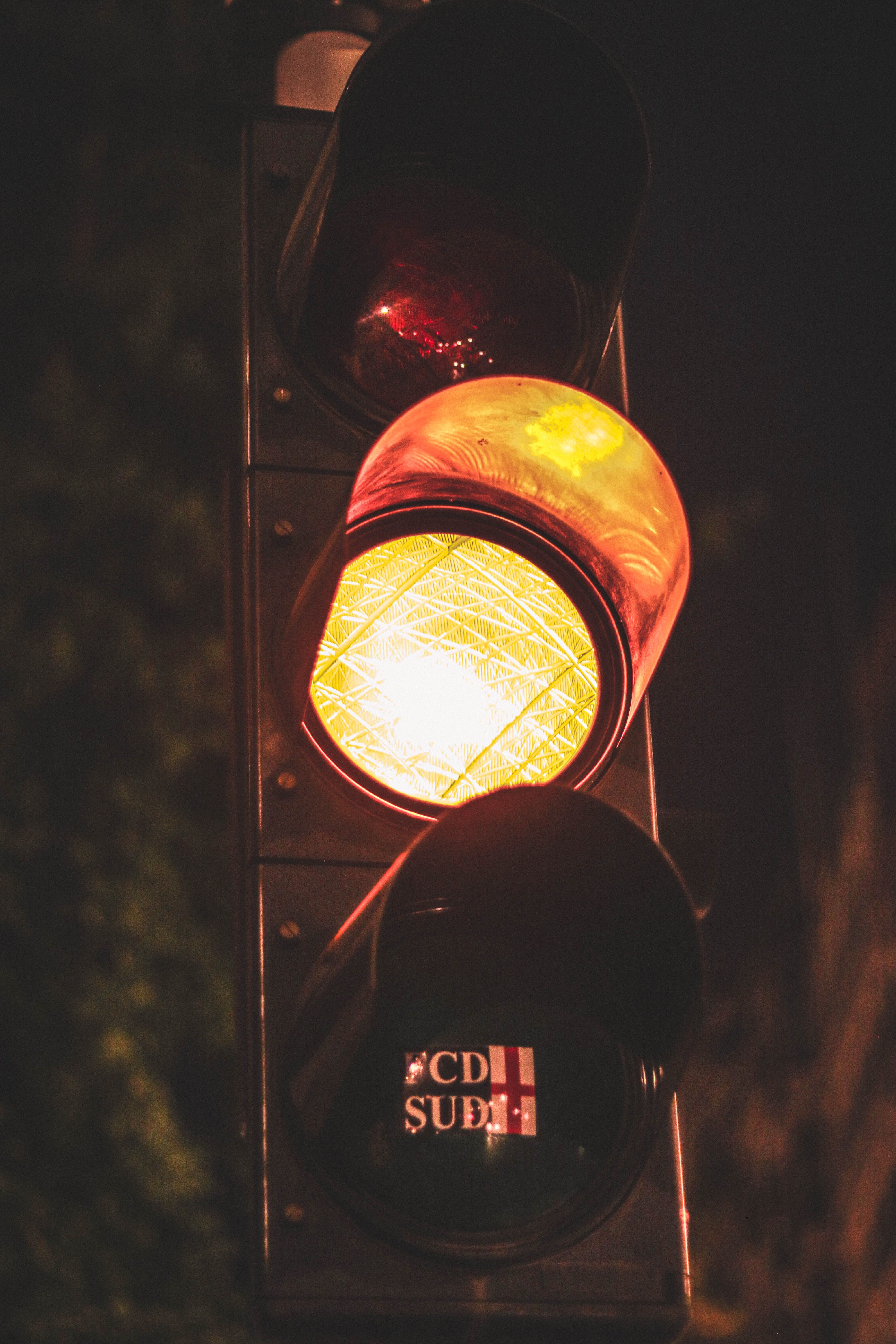 Traffic Light with Yellow Signal at Night · Free Stock Photo