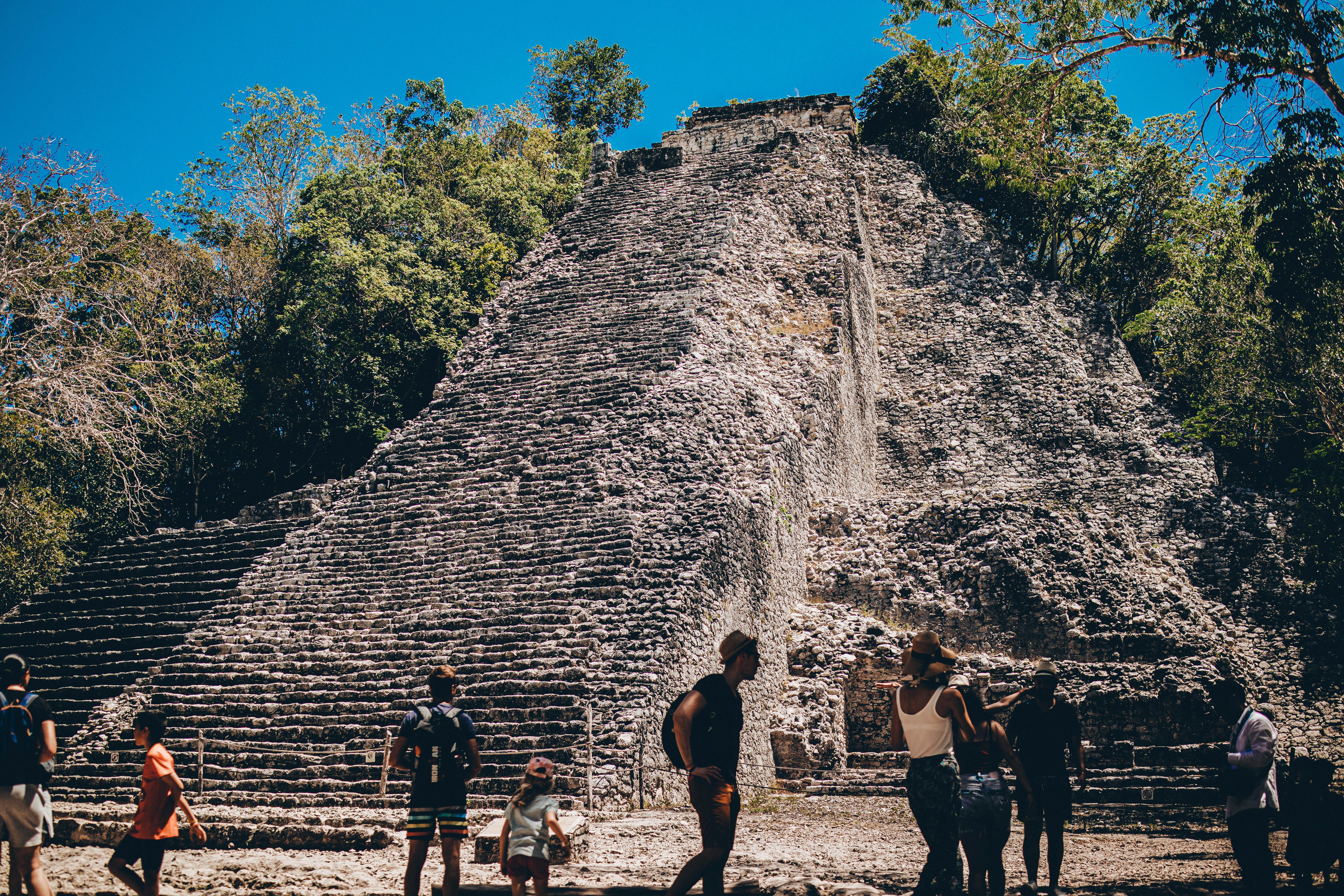 Tourists exploring ancient Mayan pyramid · Free Stock Photo