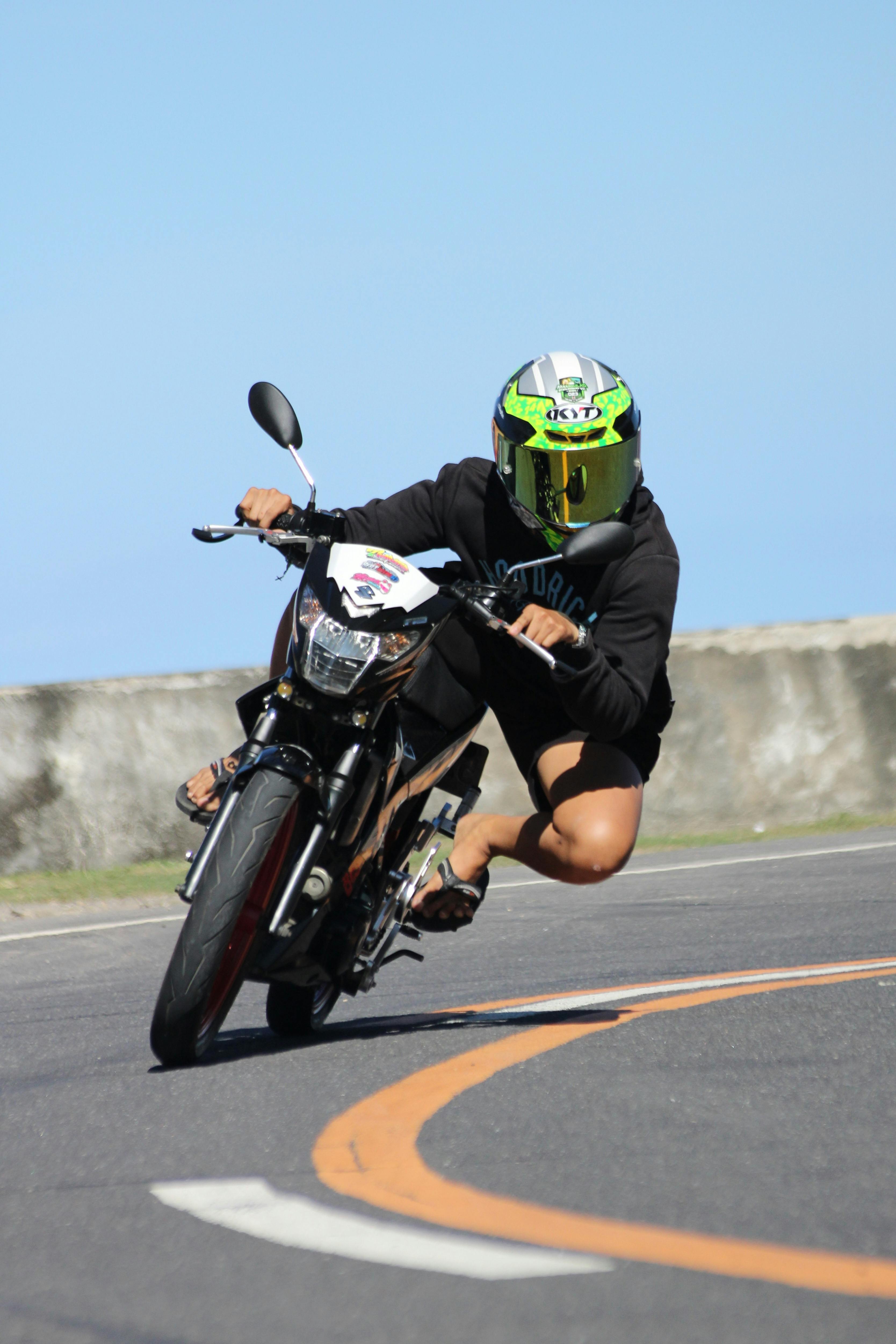 Dynamic Motorcycle Lean on Curved Road · Free Stock Photo