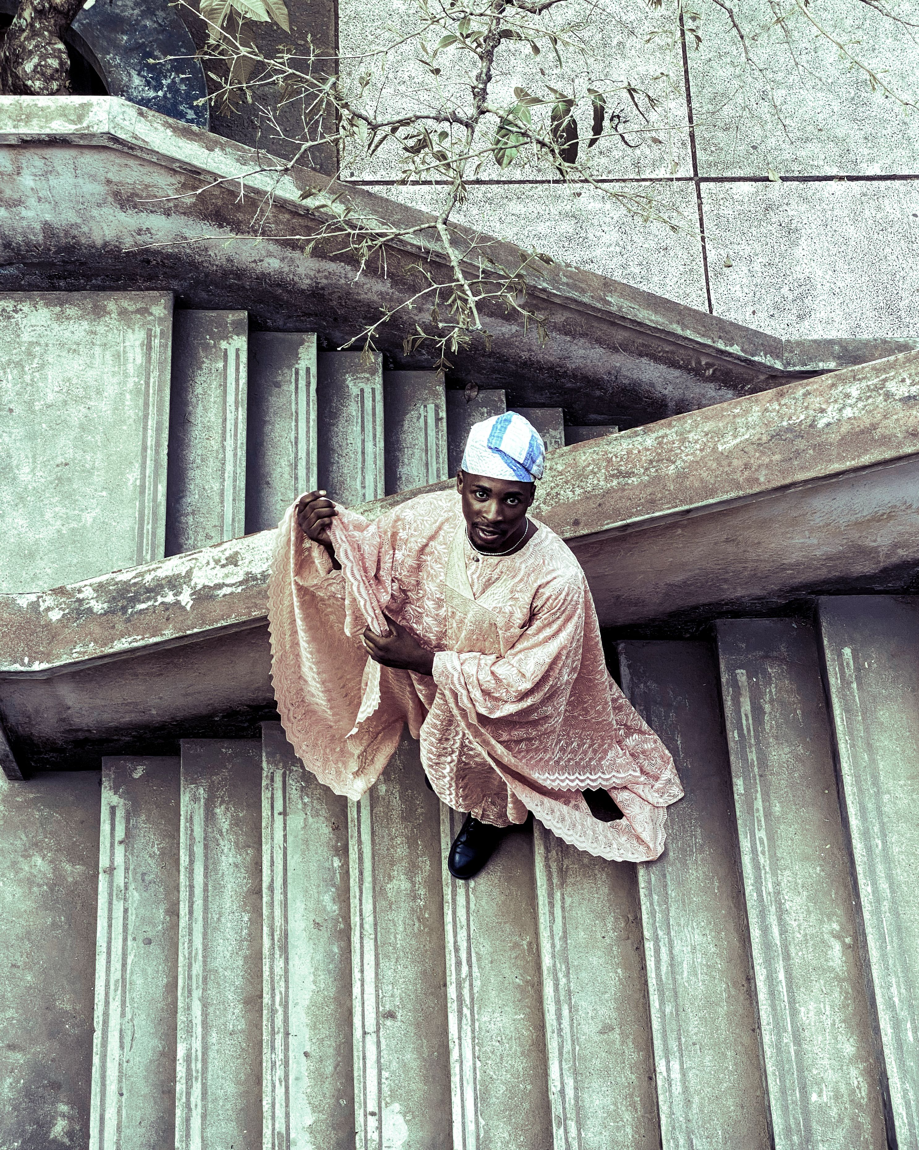 Man in Traditional Garment Ascending Concrete Staircase · Free Stock Photo