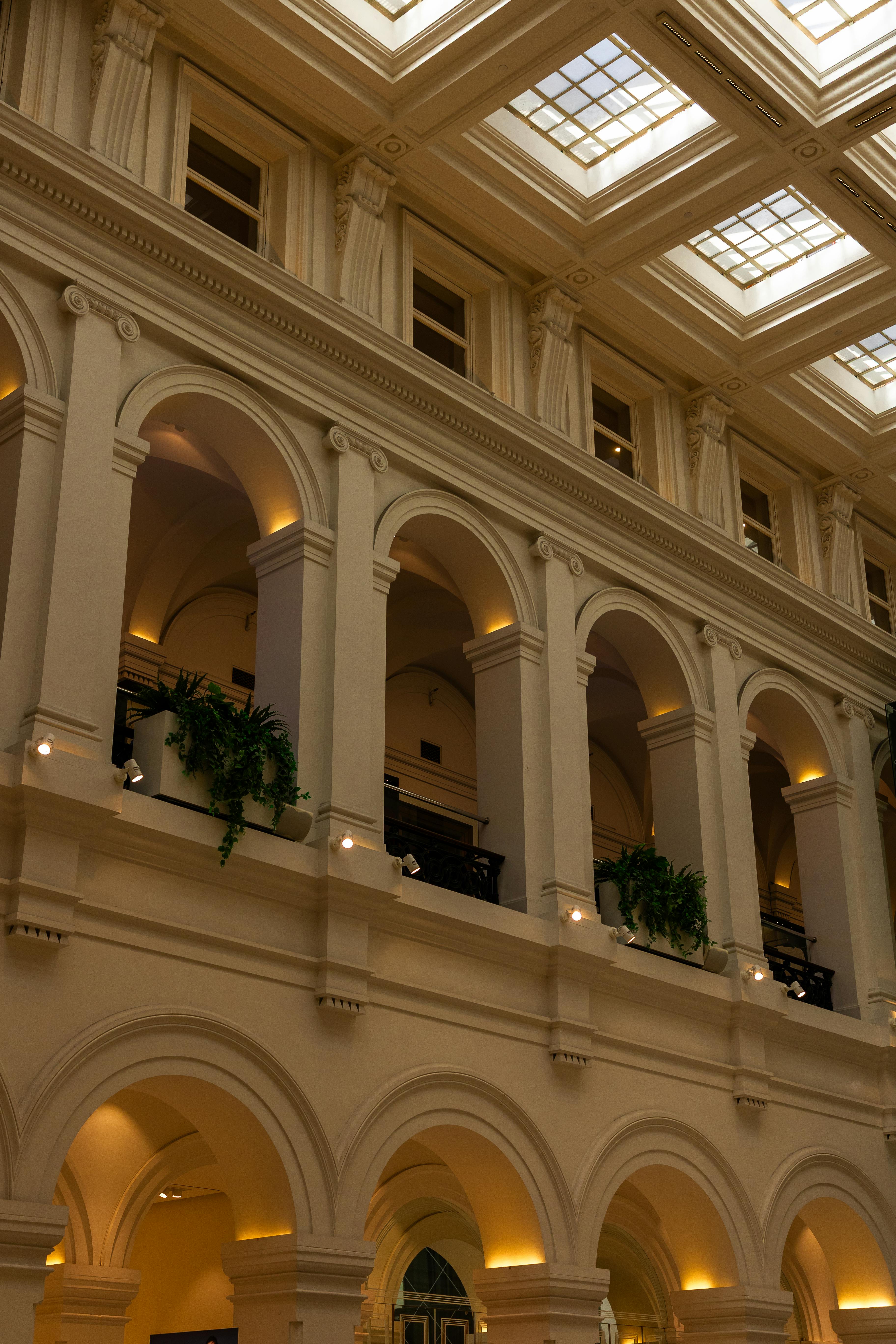 Elegant Indoor Atrium with Classical Arches · Free Stock Photo