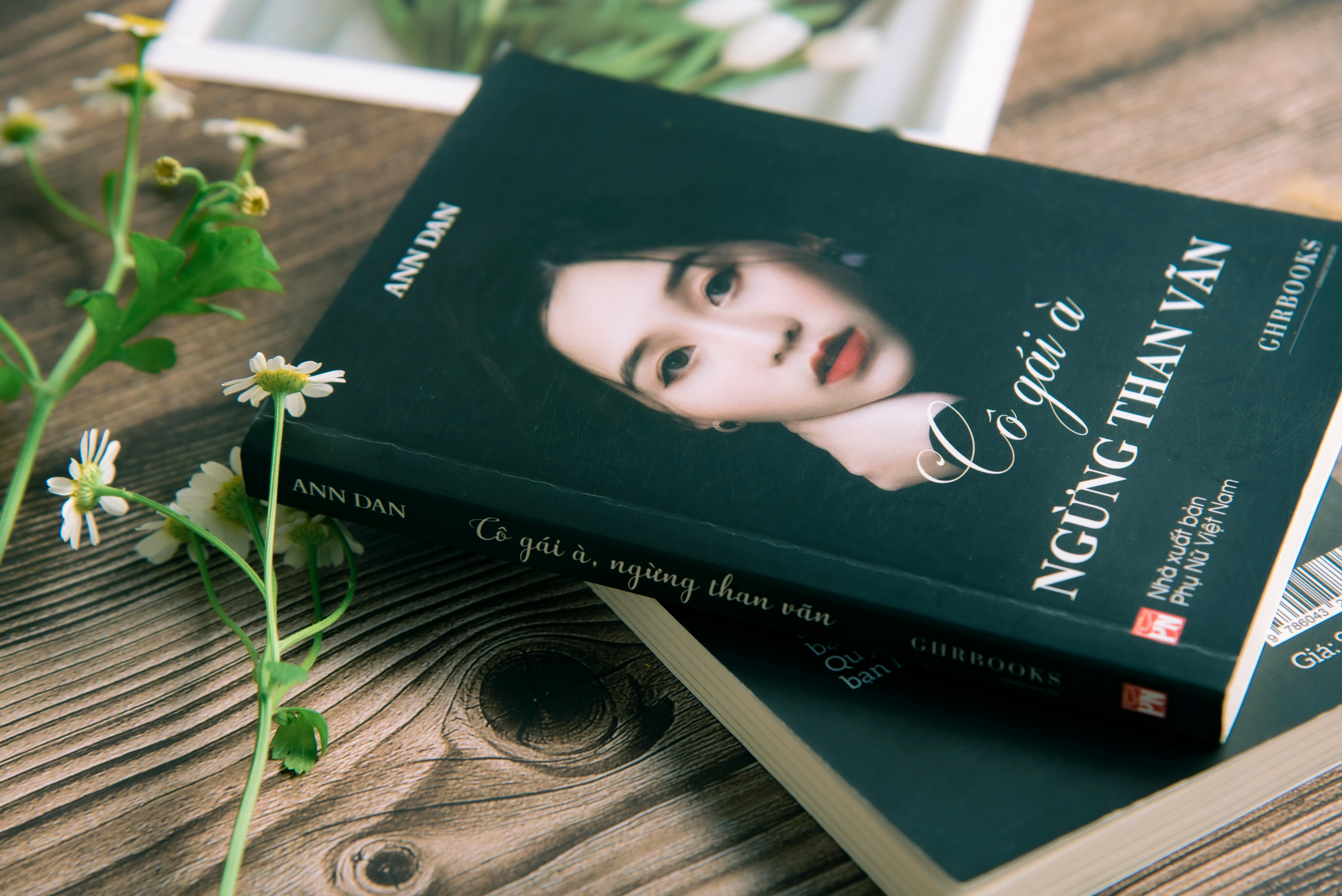 Vietnamese Book with Portrait on Wooden Table · Free Stock Photo