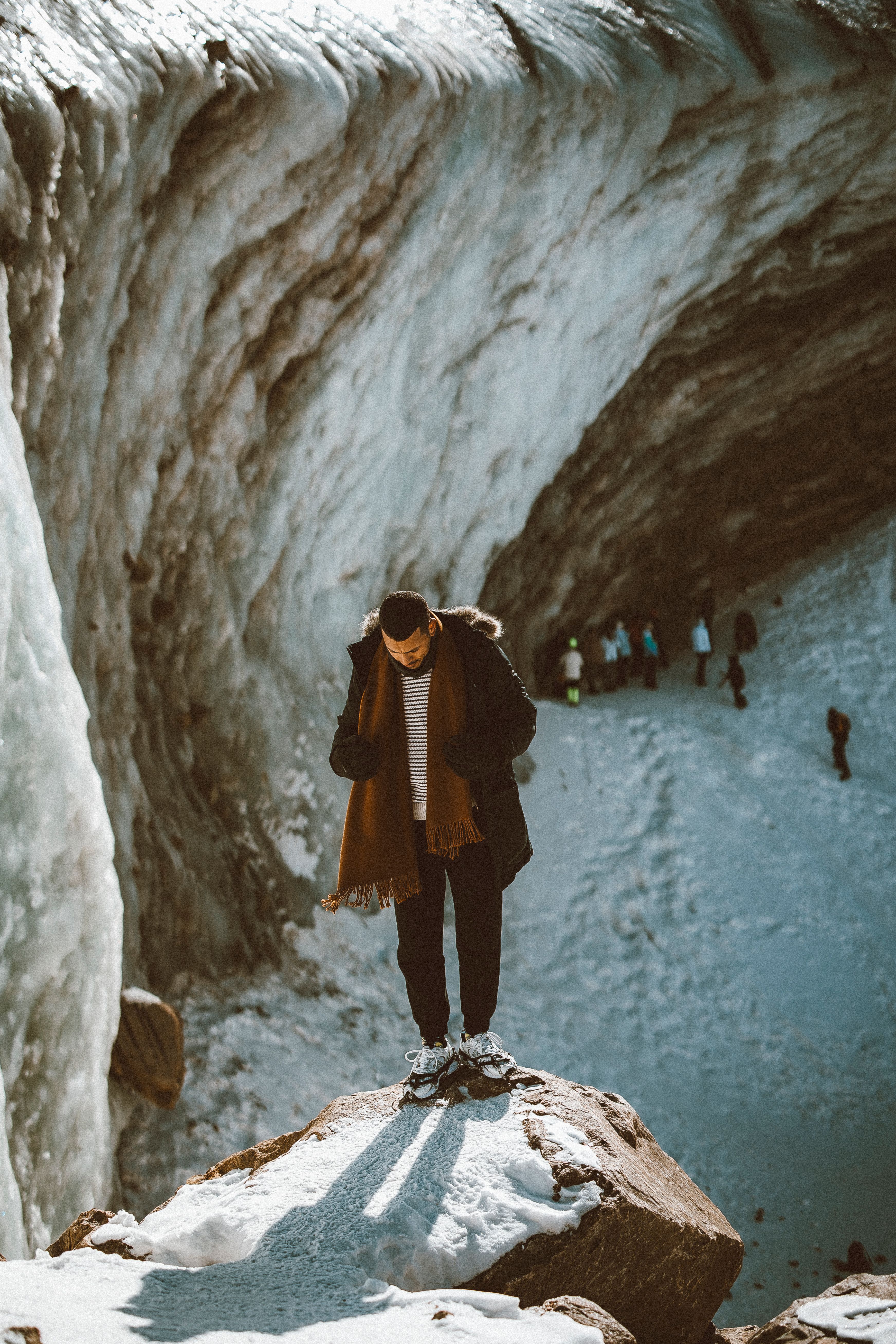 Person Standing on Snowy Rock in Winter Landscape · Free Stock Photo