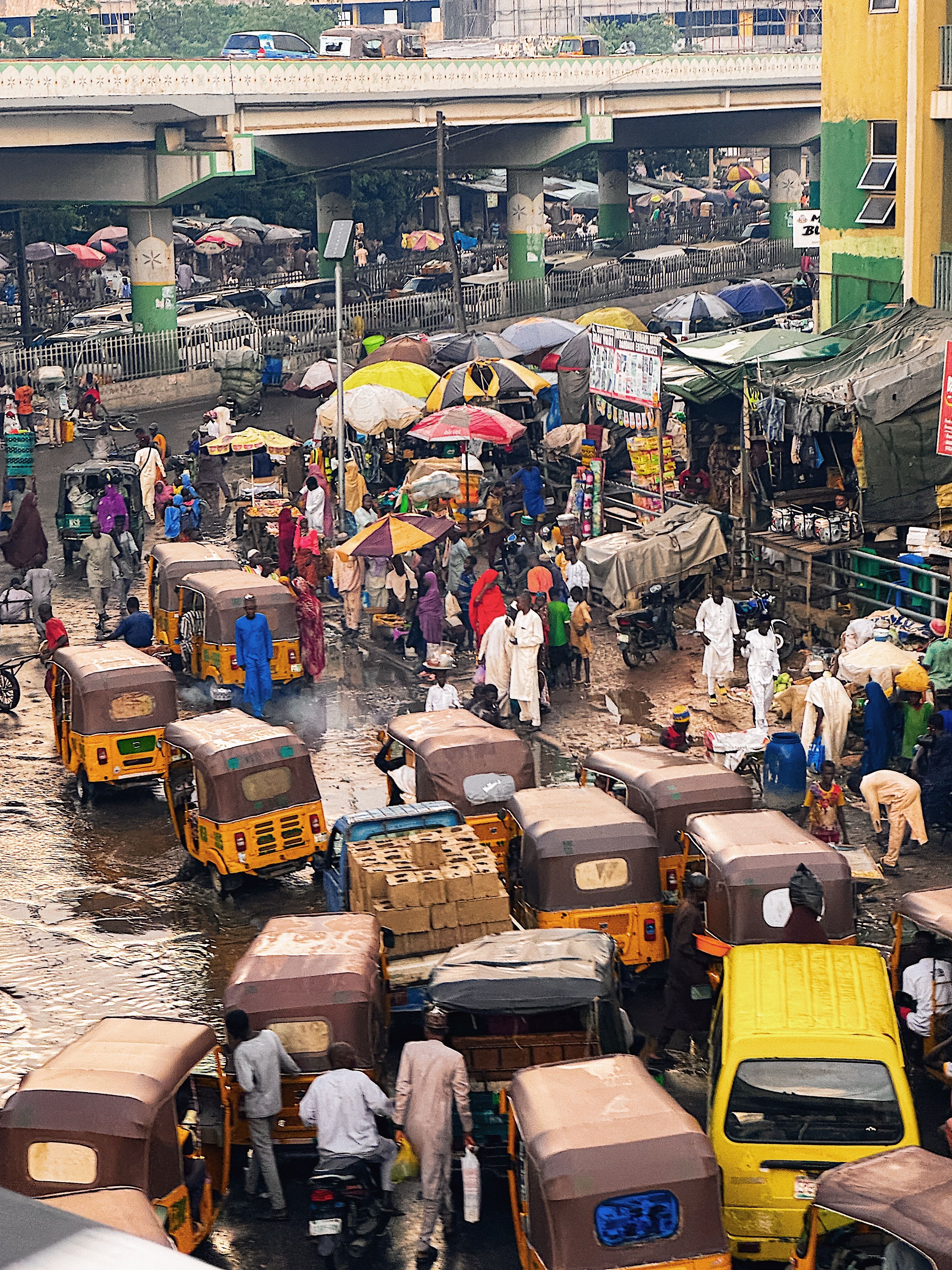 Busy Kano Market Street with Vehicles and People · Free Stock Photo