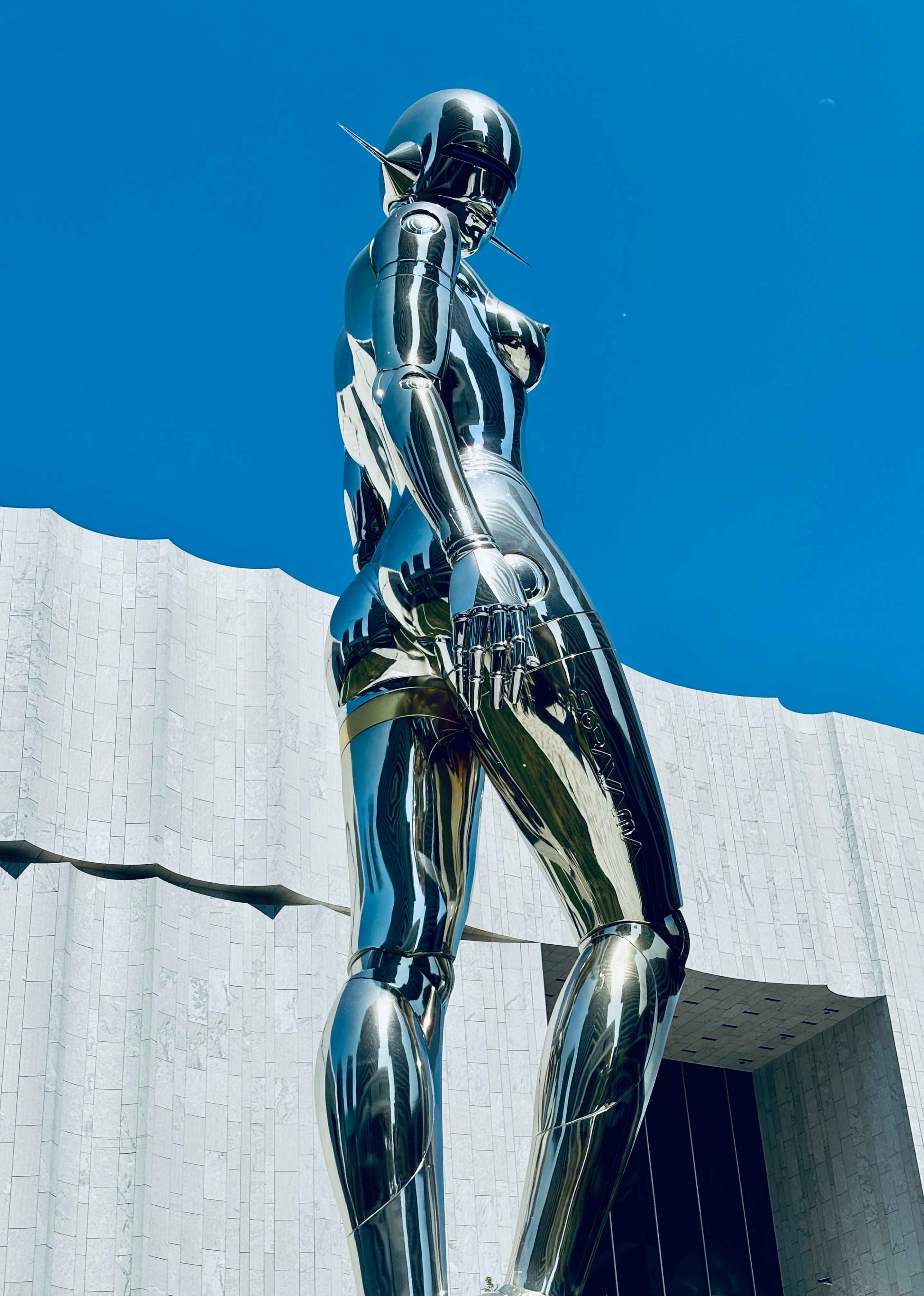 Futuristic Chrome Statue Outside Contemporary Building · Free Stock Photo
