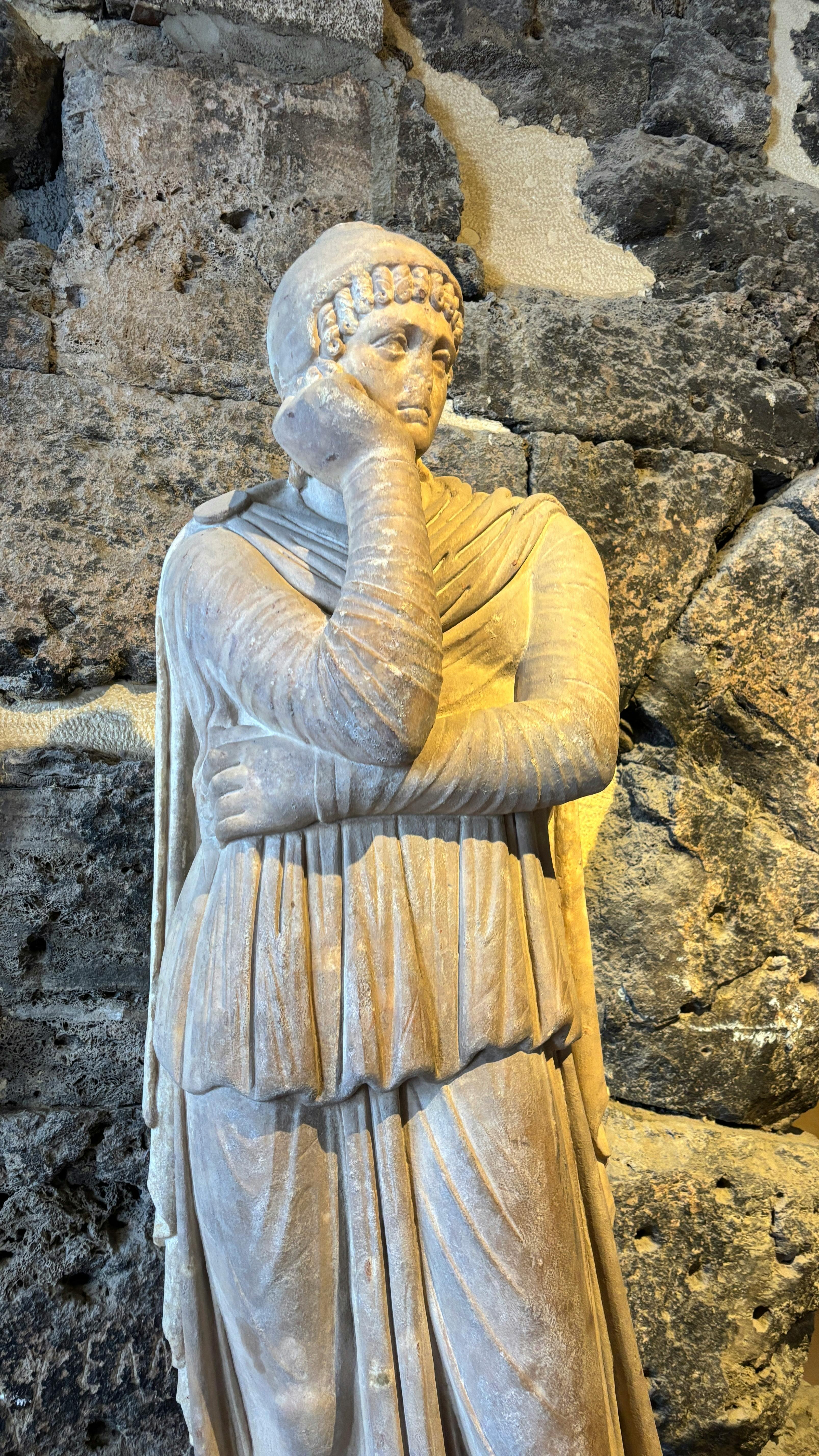 Ancient Roman Statue Against Stone Wall · Free Stock Photo