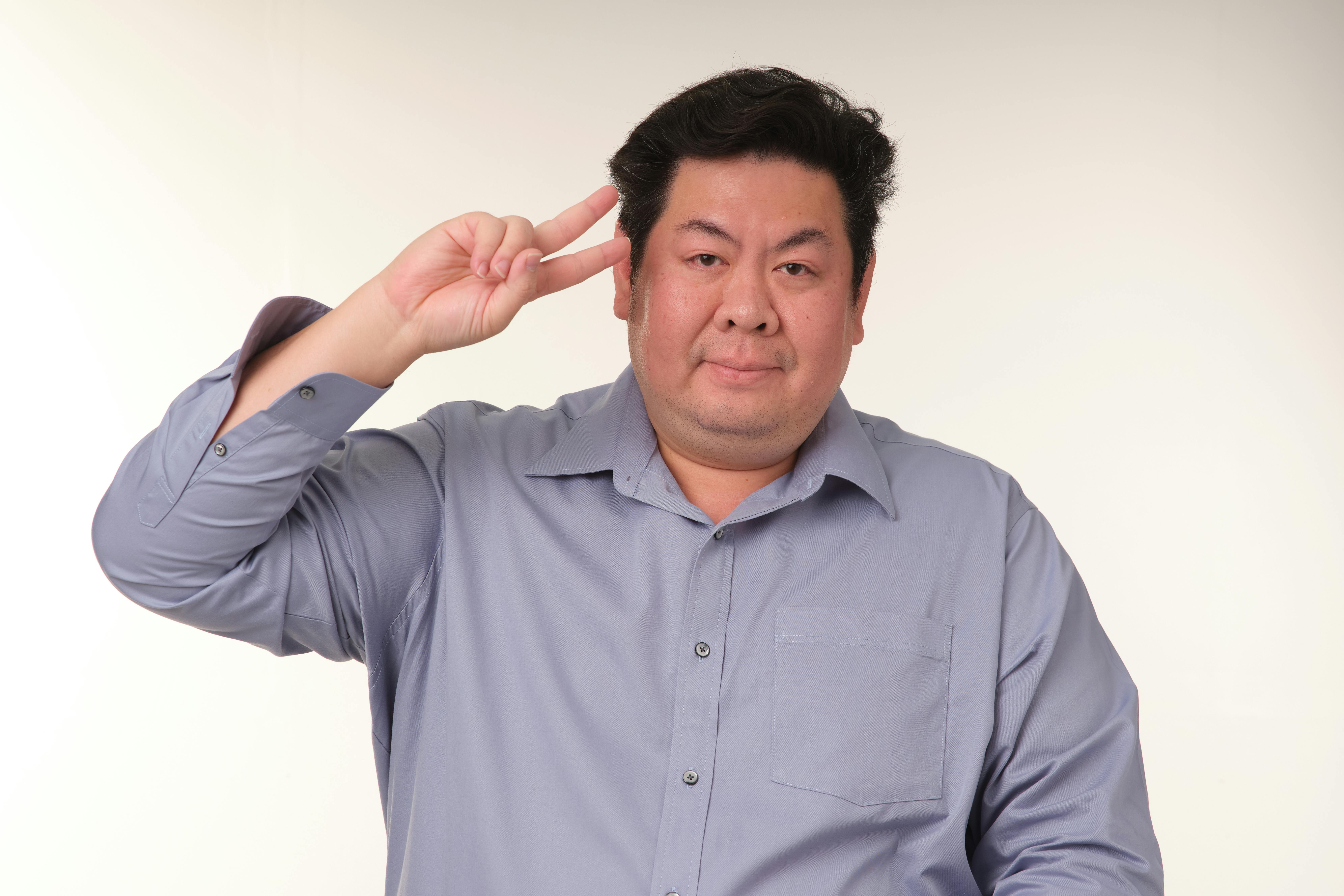 Man Making Peace Sign Gesture in Studio · Free Stock Photo