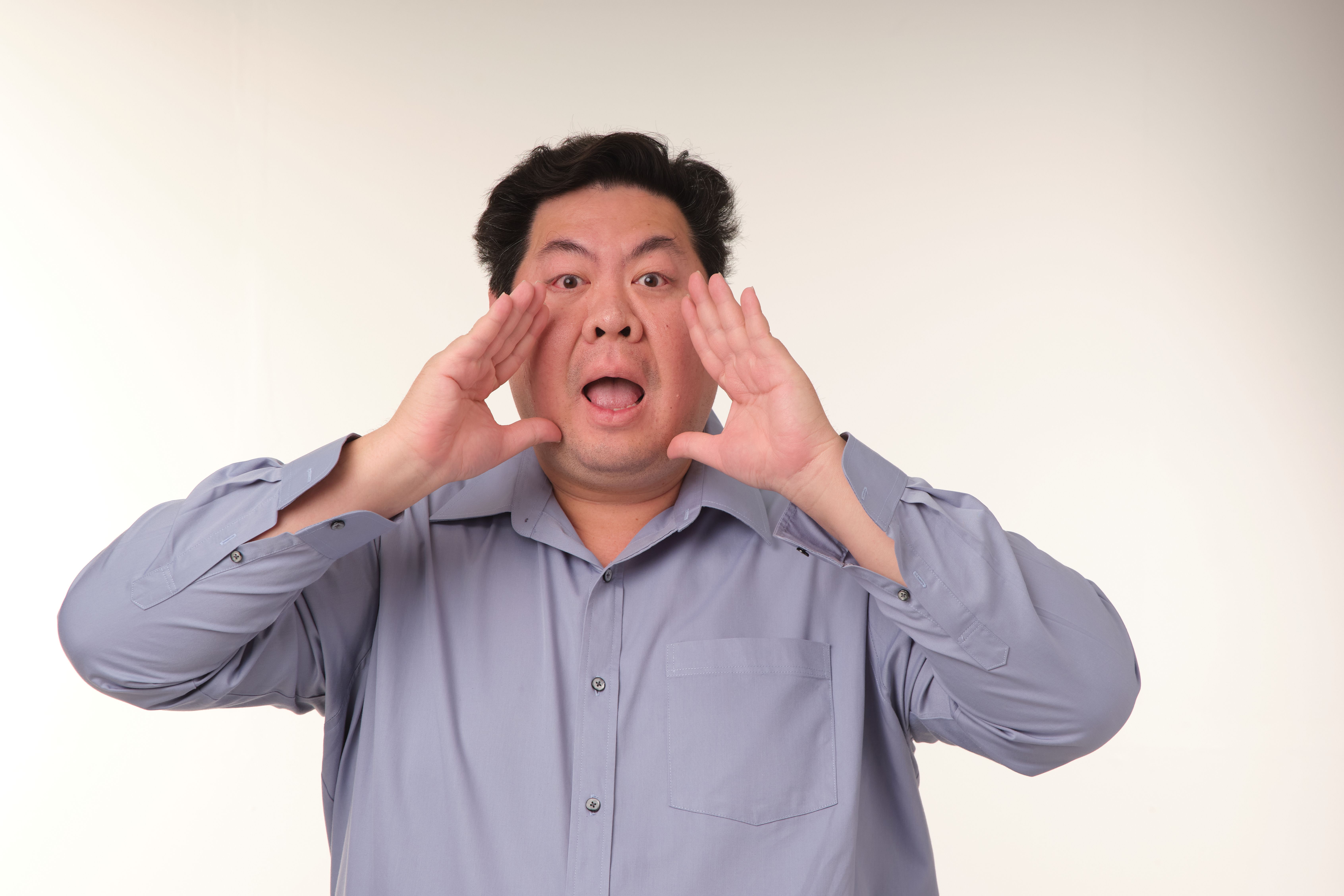 Man Shouting with Hands Near Mouth Indoors · Free Stock Photo