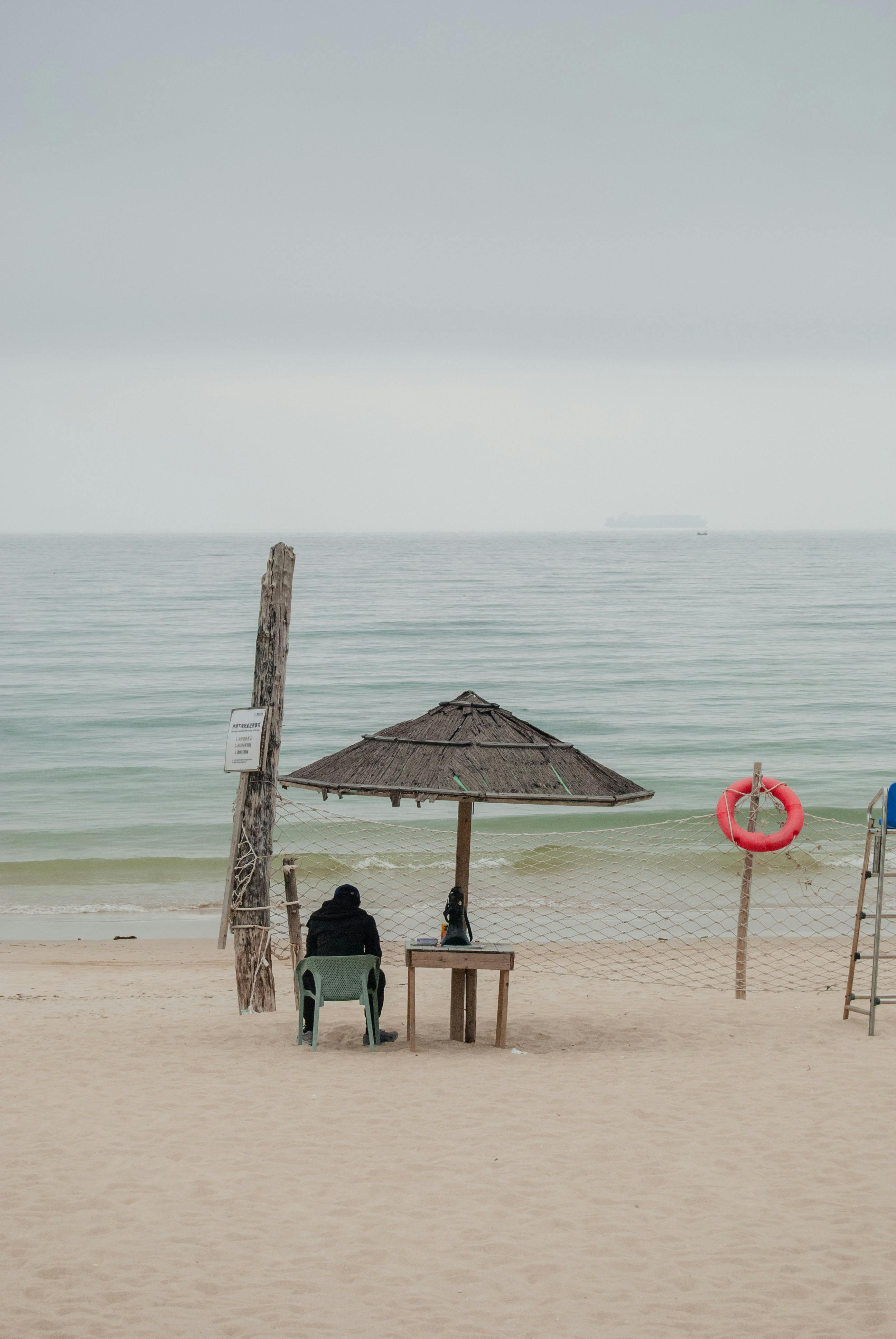 Tranquil Beach Scene with Lifeguard Chair · Free Stock Photo