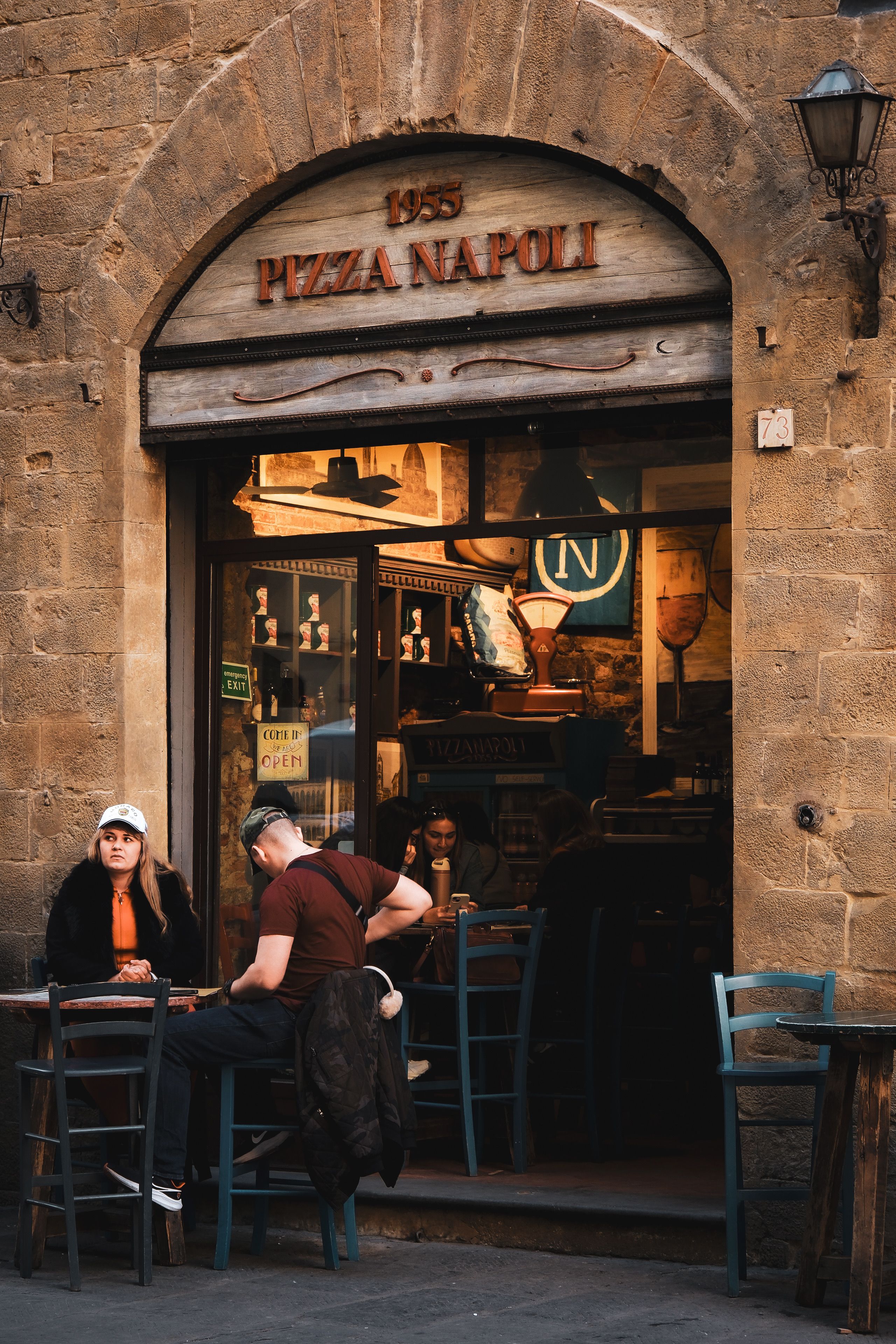 Charming Italian Cafe Facade with Patrons · Free Stock Photo