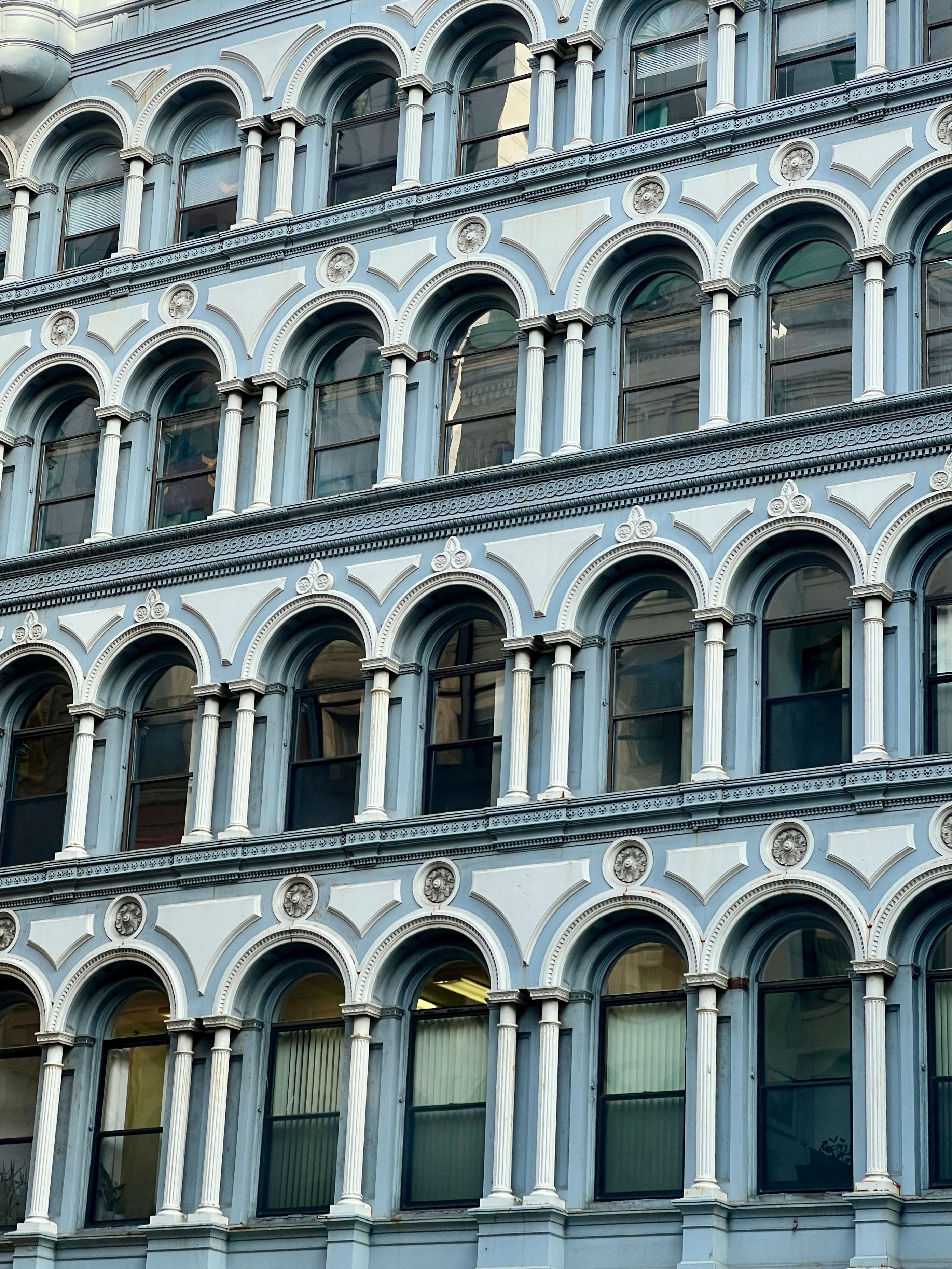 Classic Architectural Facade with Arched Windows · Free Stock Photo