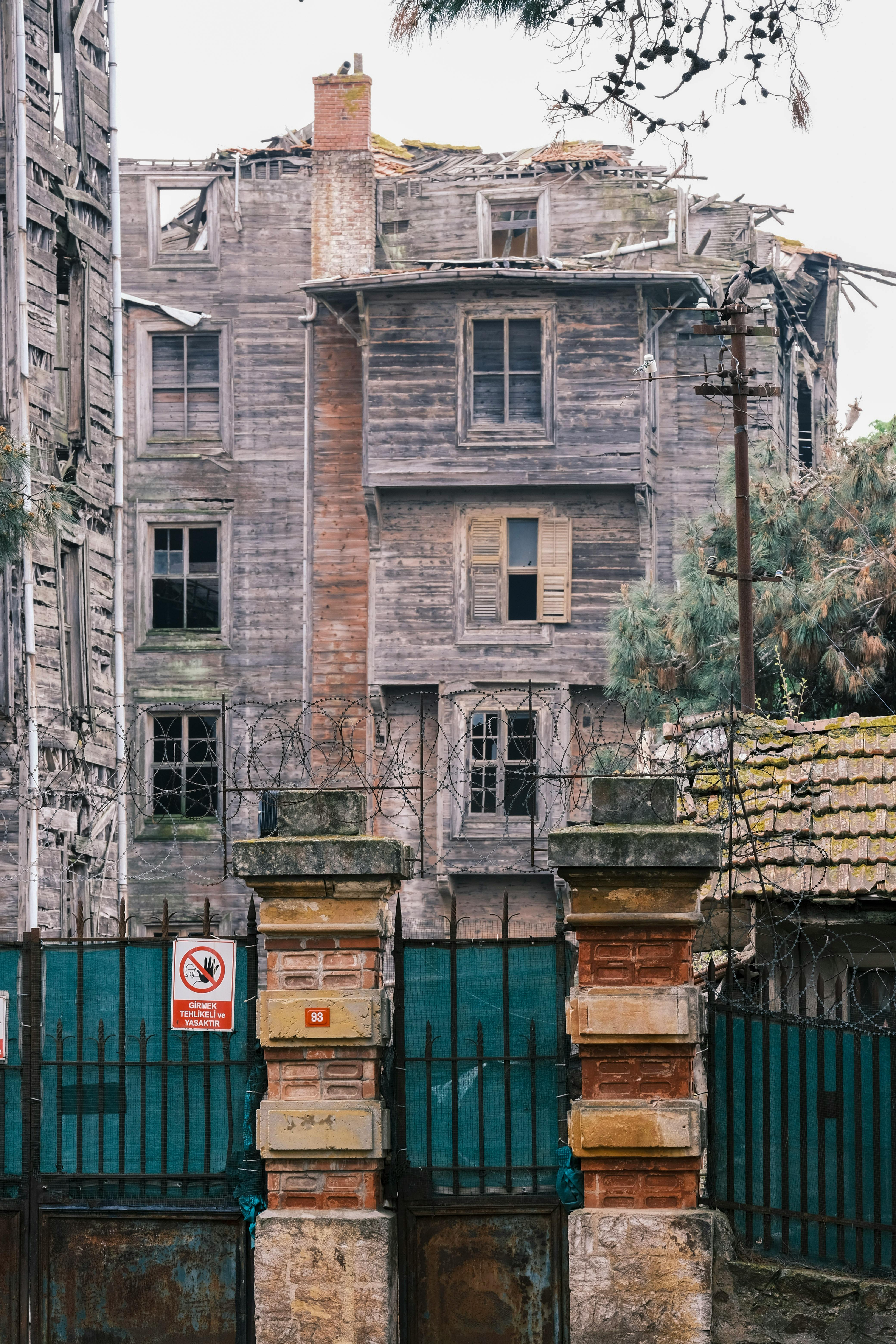 Abandoned Weathered Building with Gated Entrance · Free Stock Photo