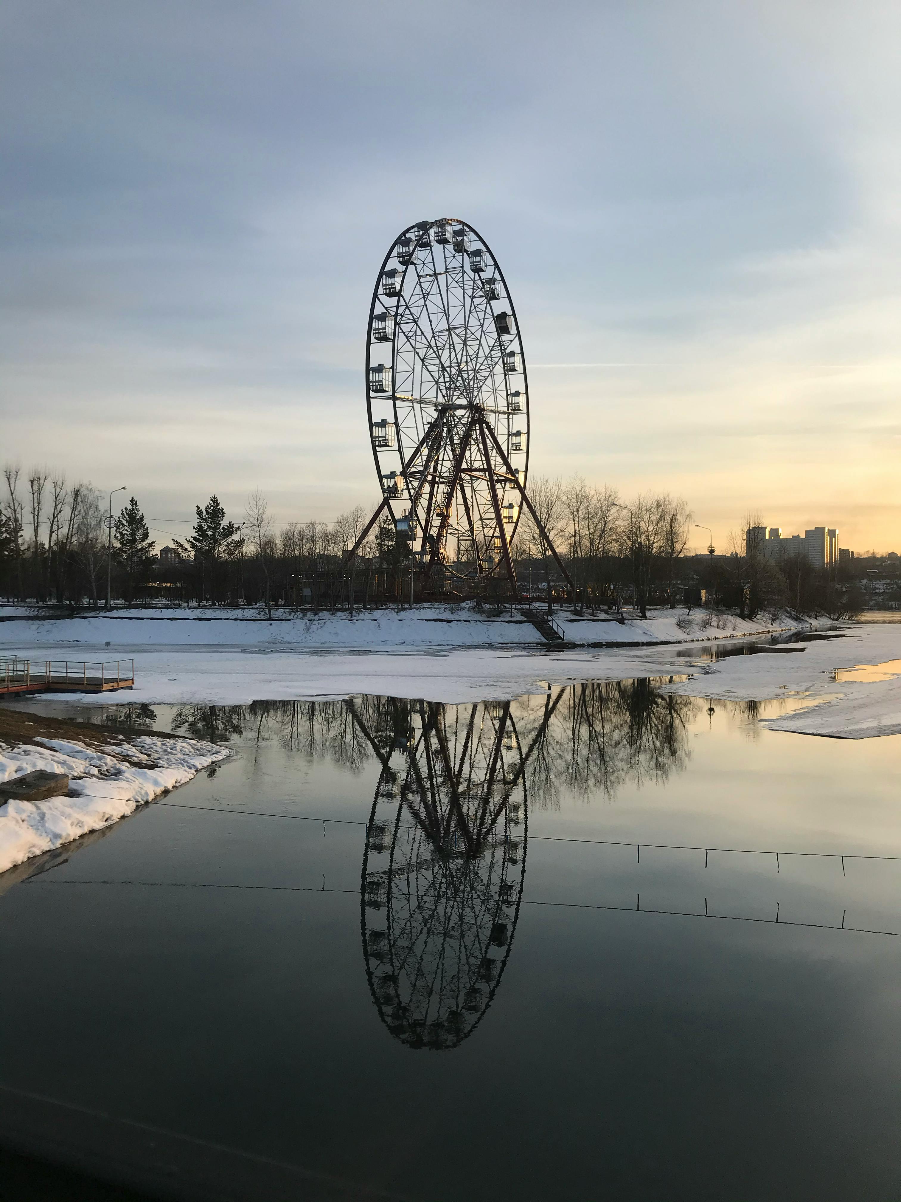 Ferris Wheel Reflection in Winter Landscape · Free Stock Photo