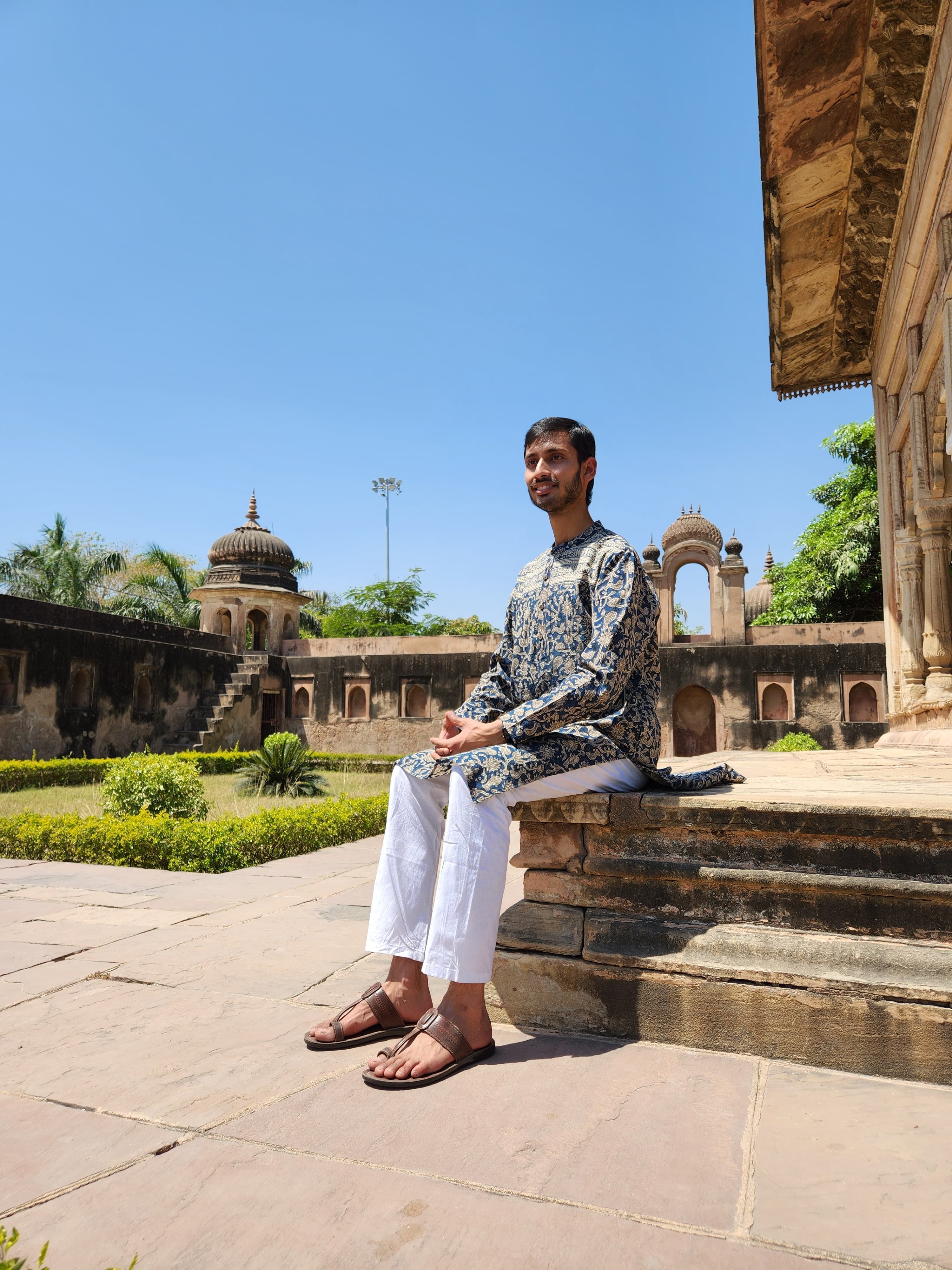 Serene Man in Traditional Attire at Historical Site · Free Stock Photo