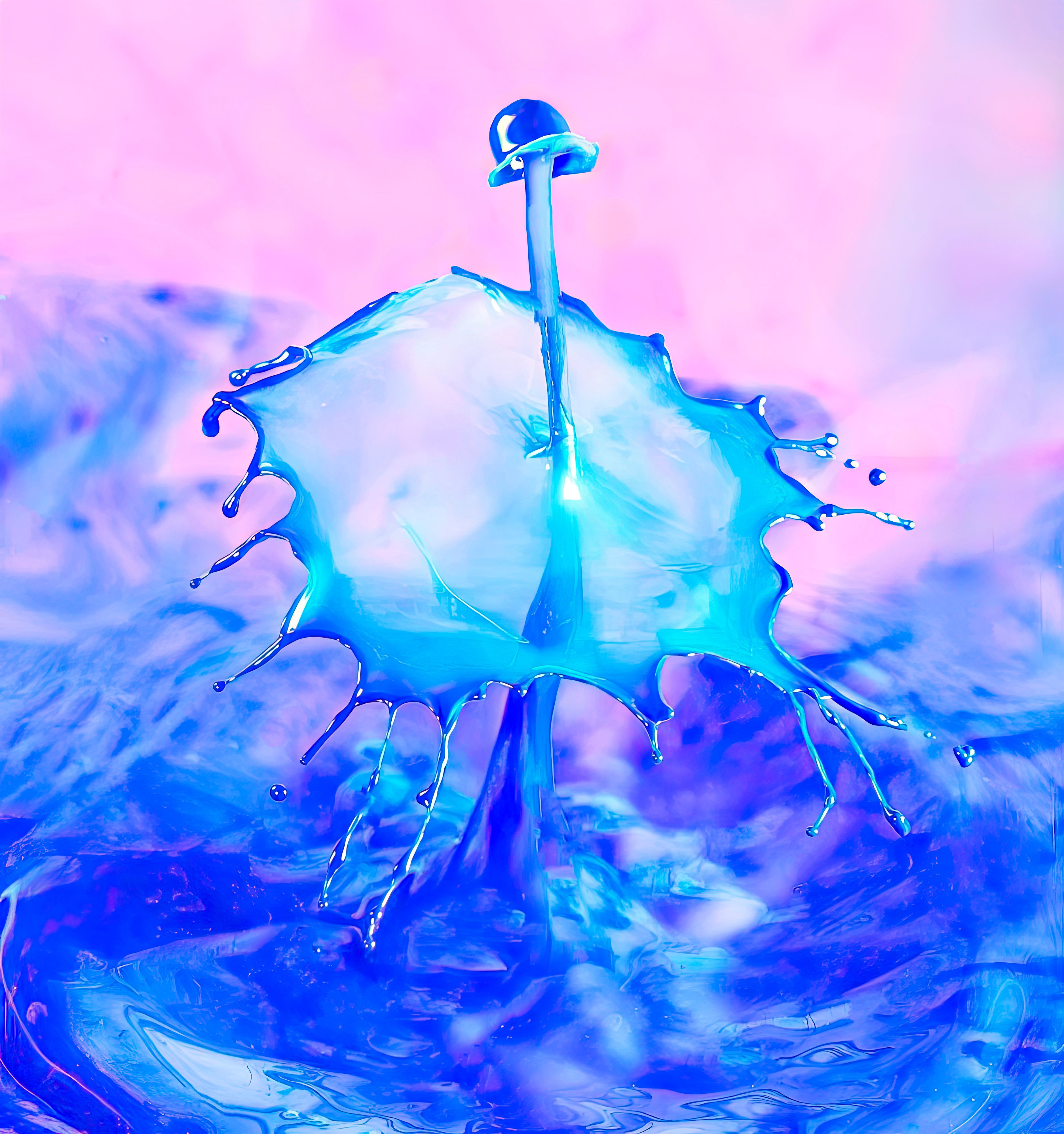 Vibrant Blue Water Splash Against Pink Background · Free Stock Photo