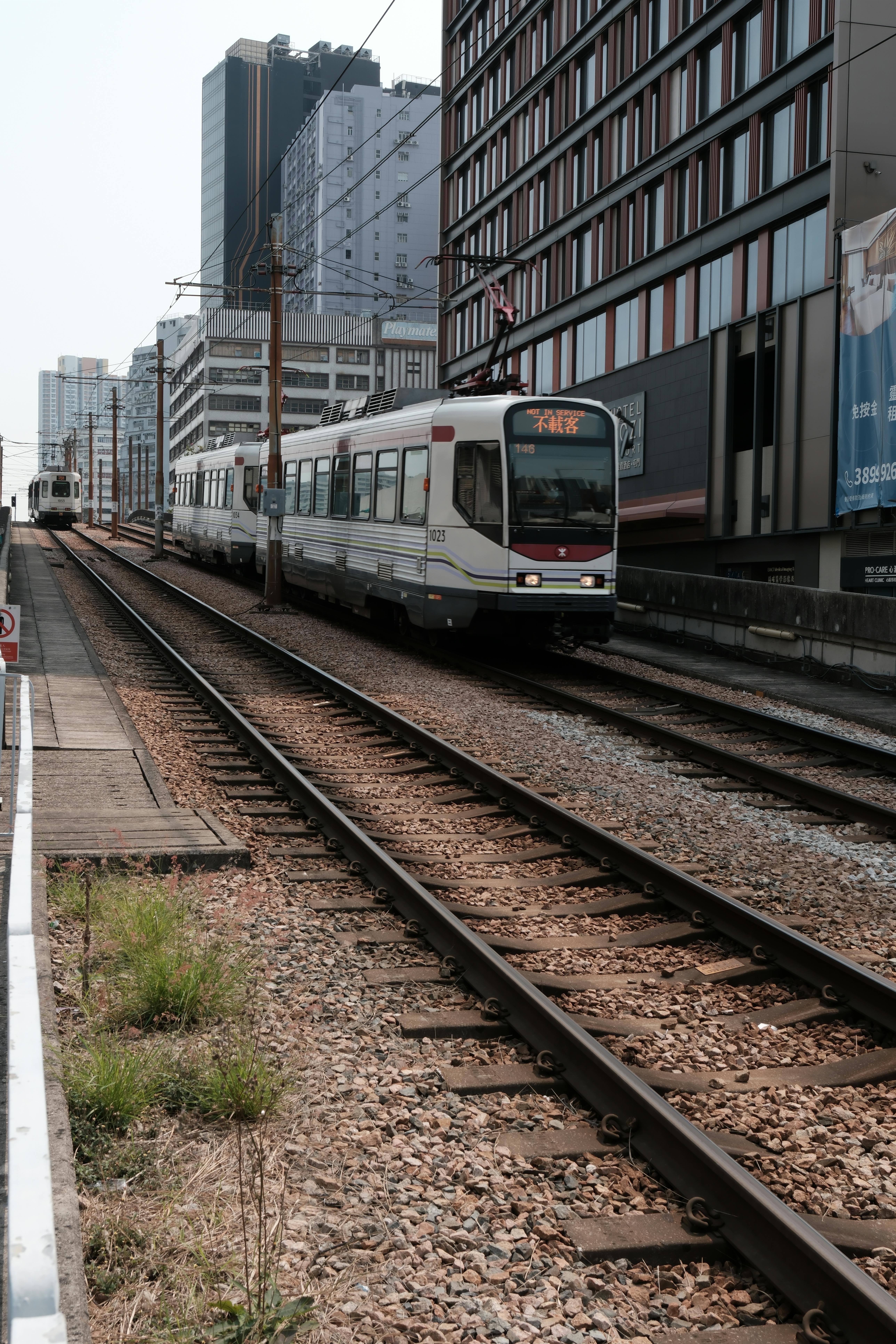 Urban Train on Railway Tracks in Cityscape · Free Stock Photo