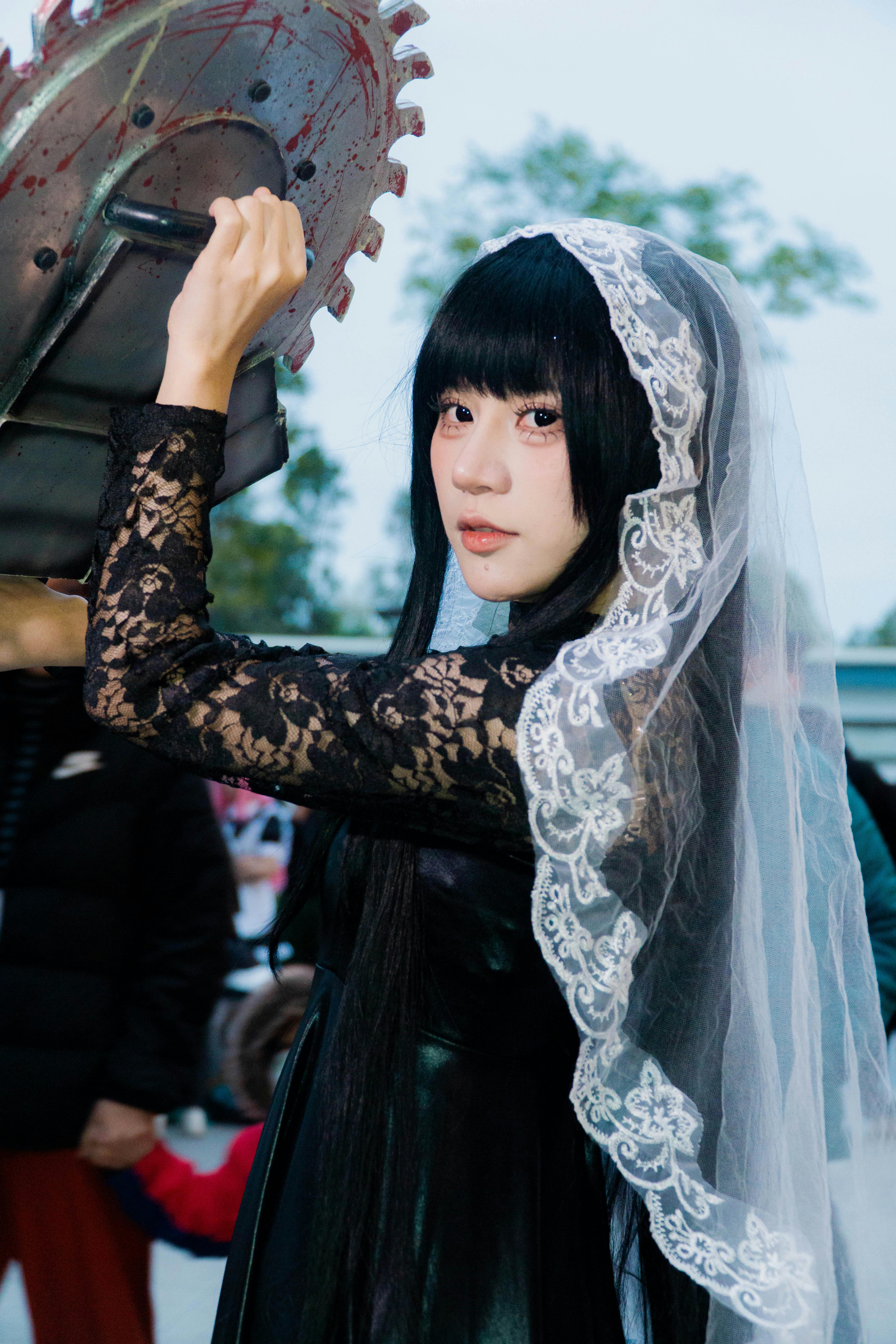 Gothic Bride with Chainsaw at Cosplay Event · Free Stock Photo