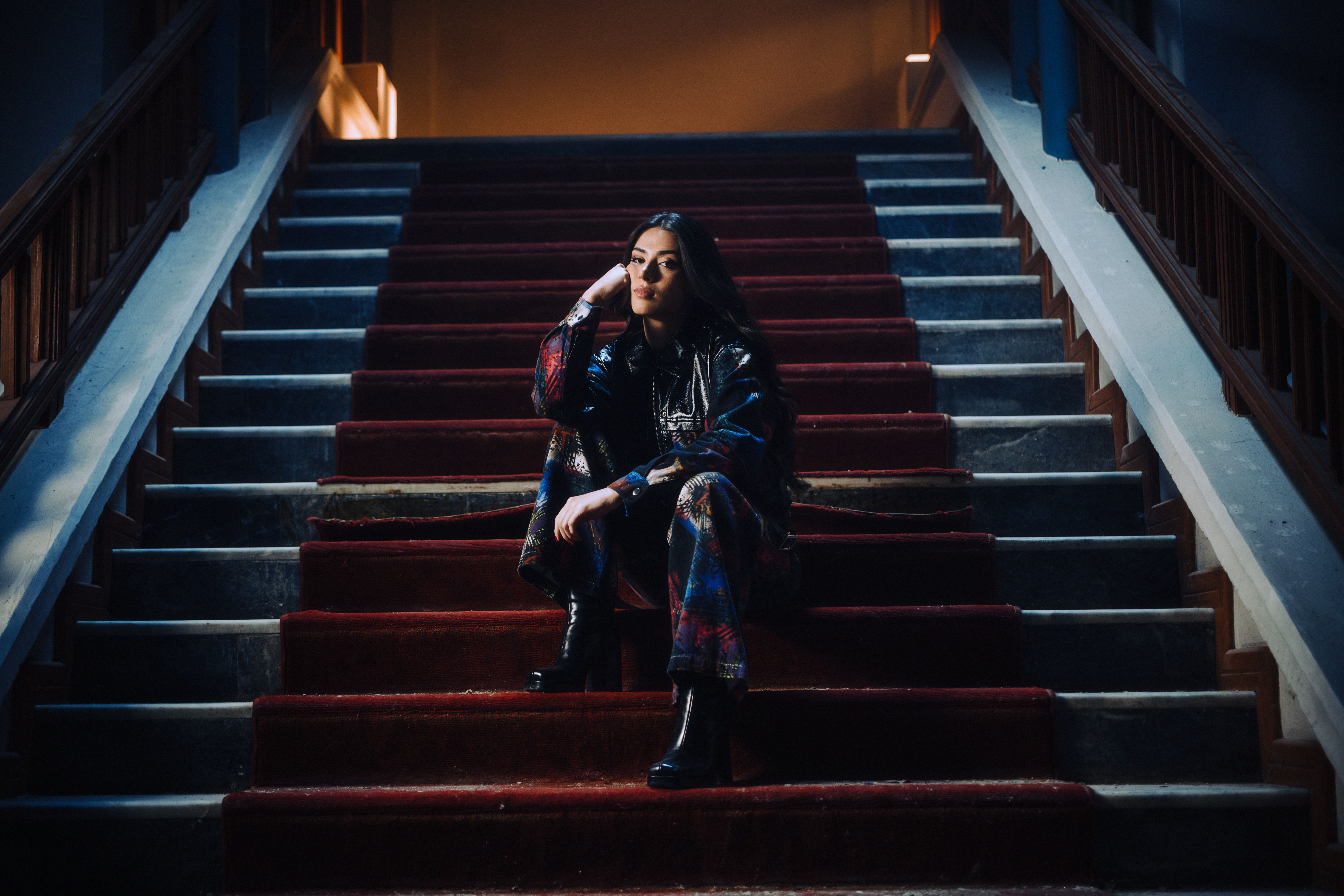 Stylish Woman Posing on Luxurious Staircase · Free Stock Photo