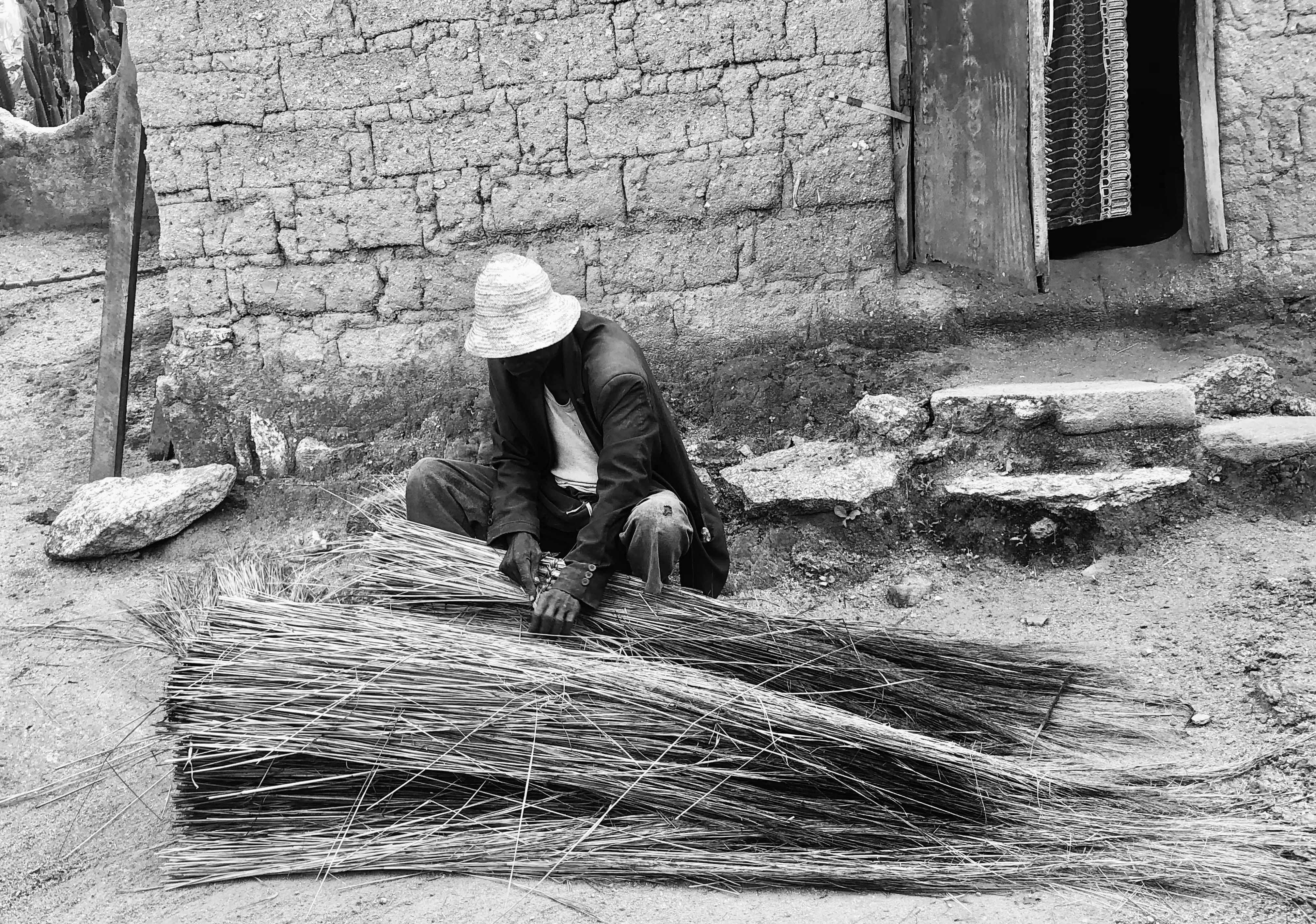 Black and White Photo of Man Making Broom Outdoors · Free Stock Photo