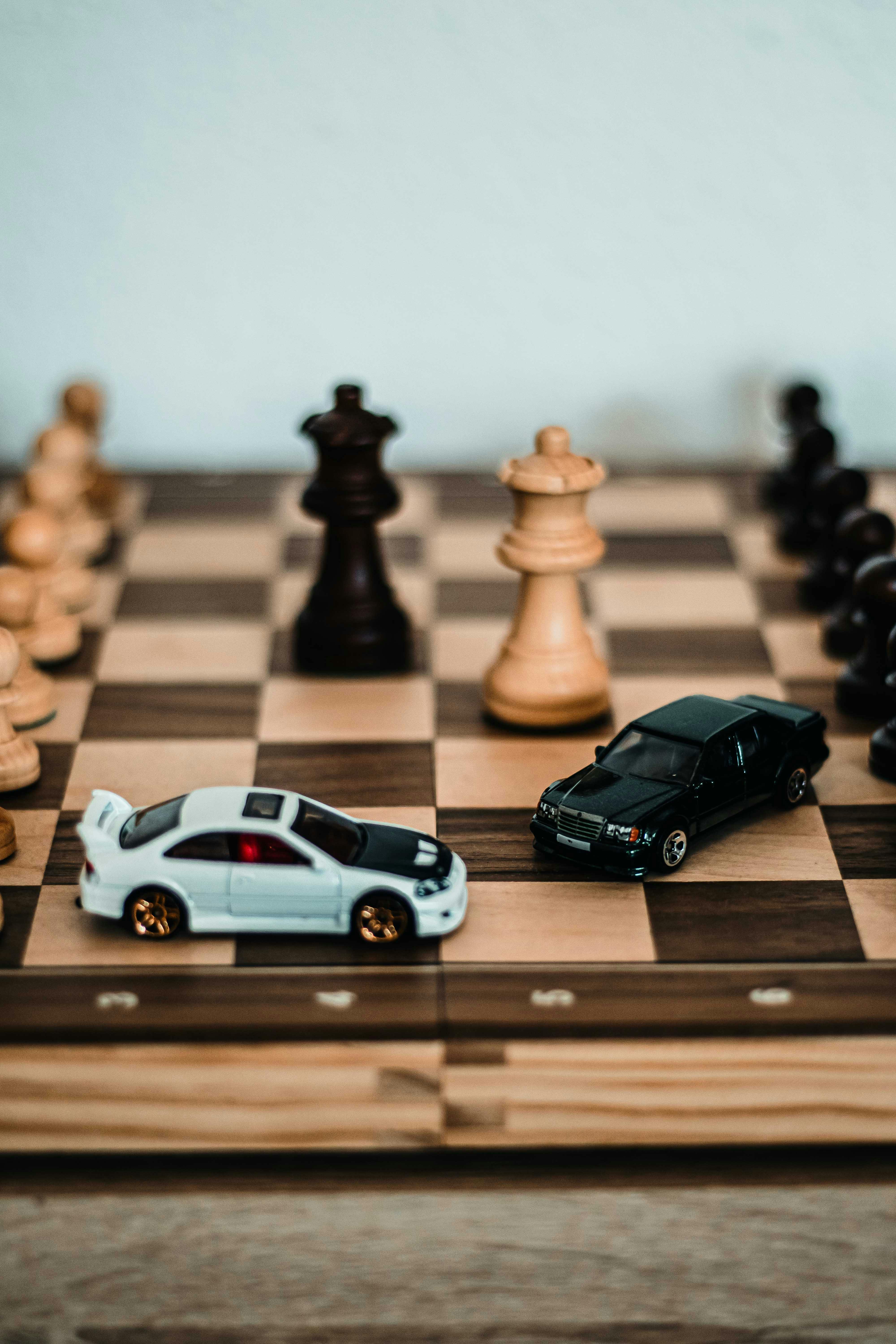 Miniature Cars on a Chess Board Close-up · Free Stock Photo