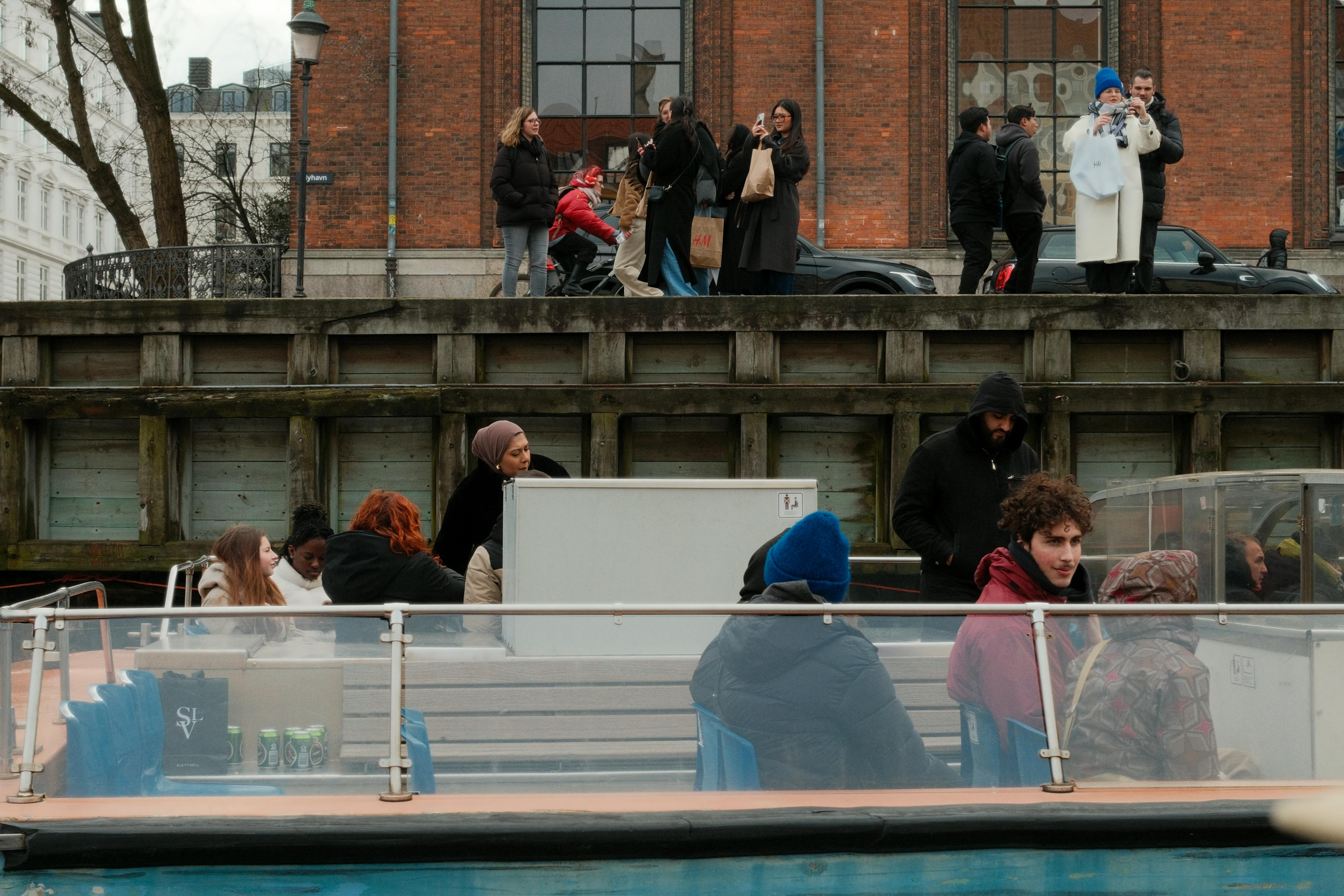 Busy Waterfront Scene with Diverse People · Free Stock Photo