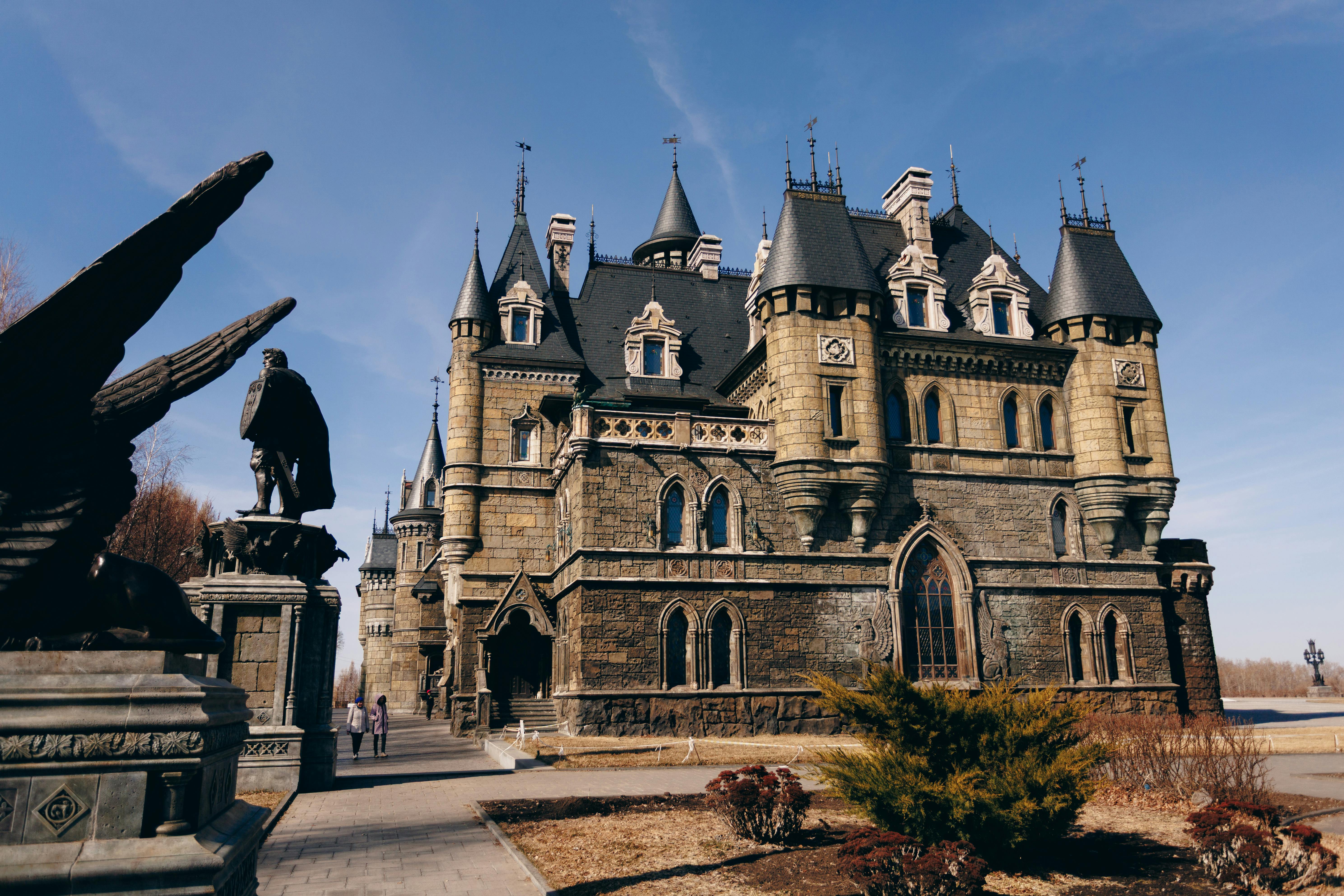 Majestic Gothic Castle in Serene Landscape · Free Stock Photo