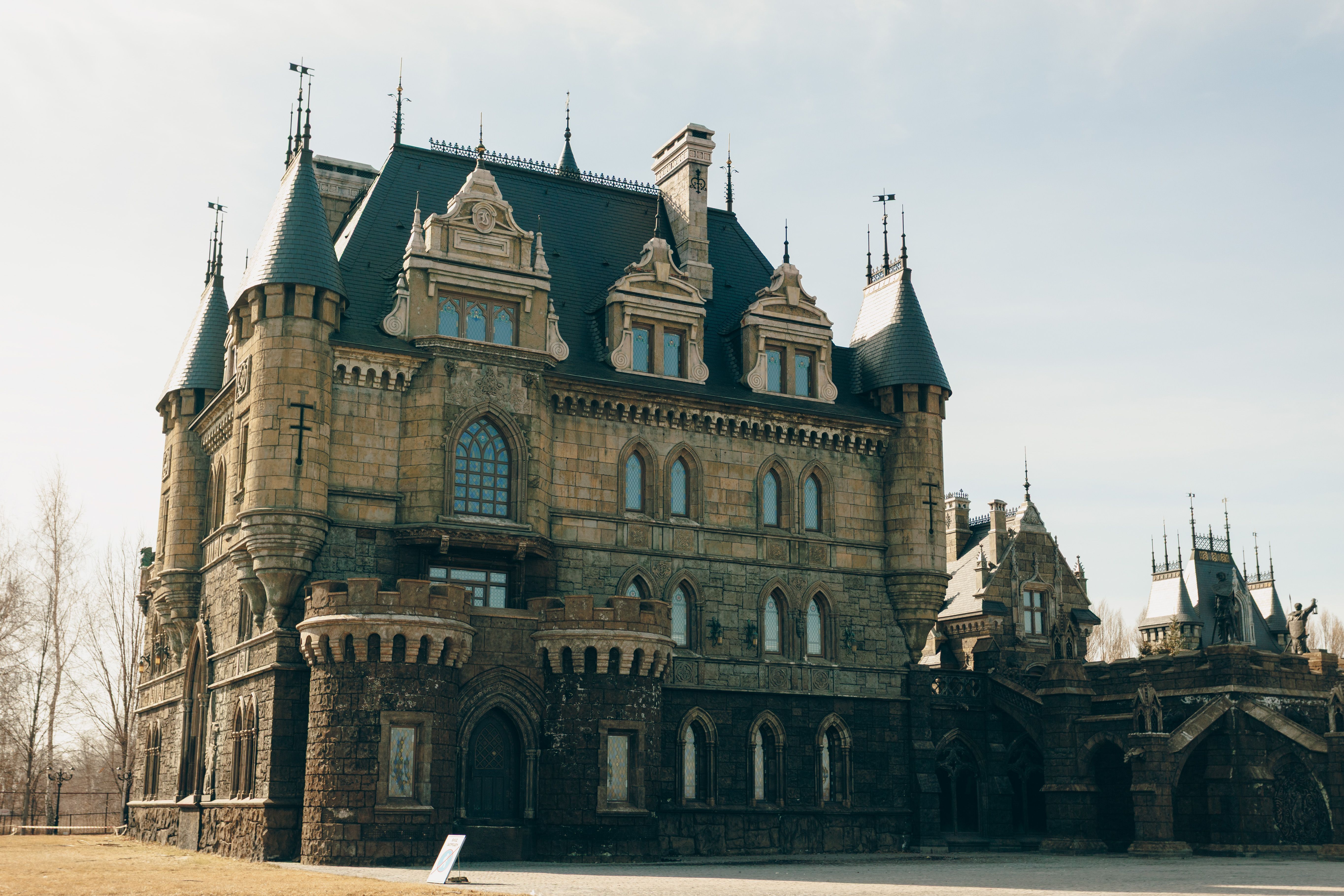 Majestic Gothic Castle in Scenic Outdoor Setting · Free Stock Photo
