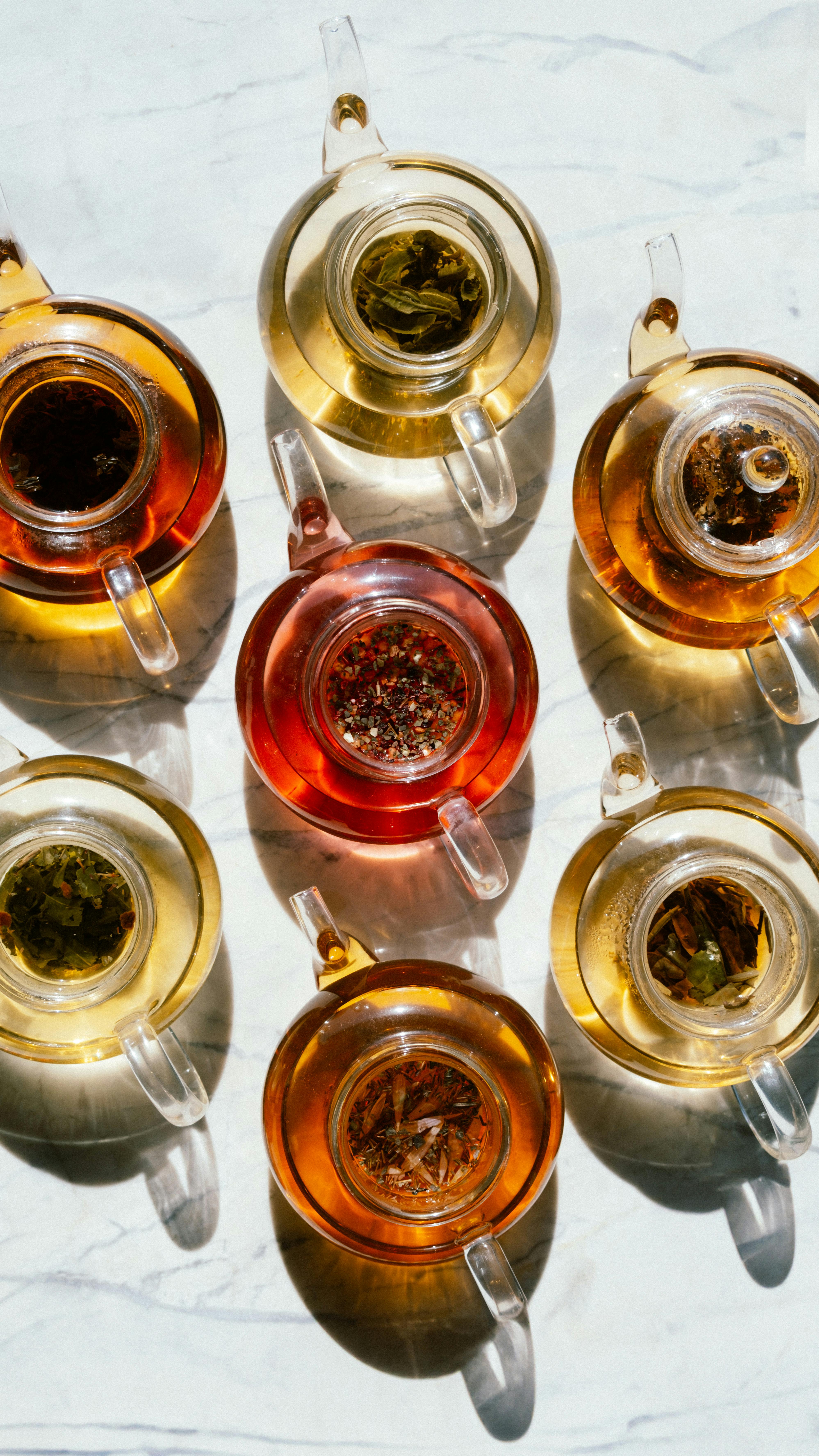 Colorful Assorted Herbal Tea in Glass Teapots · Free Stock Photo