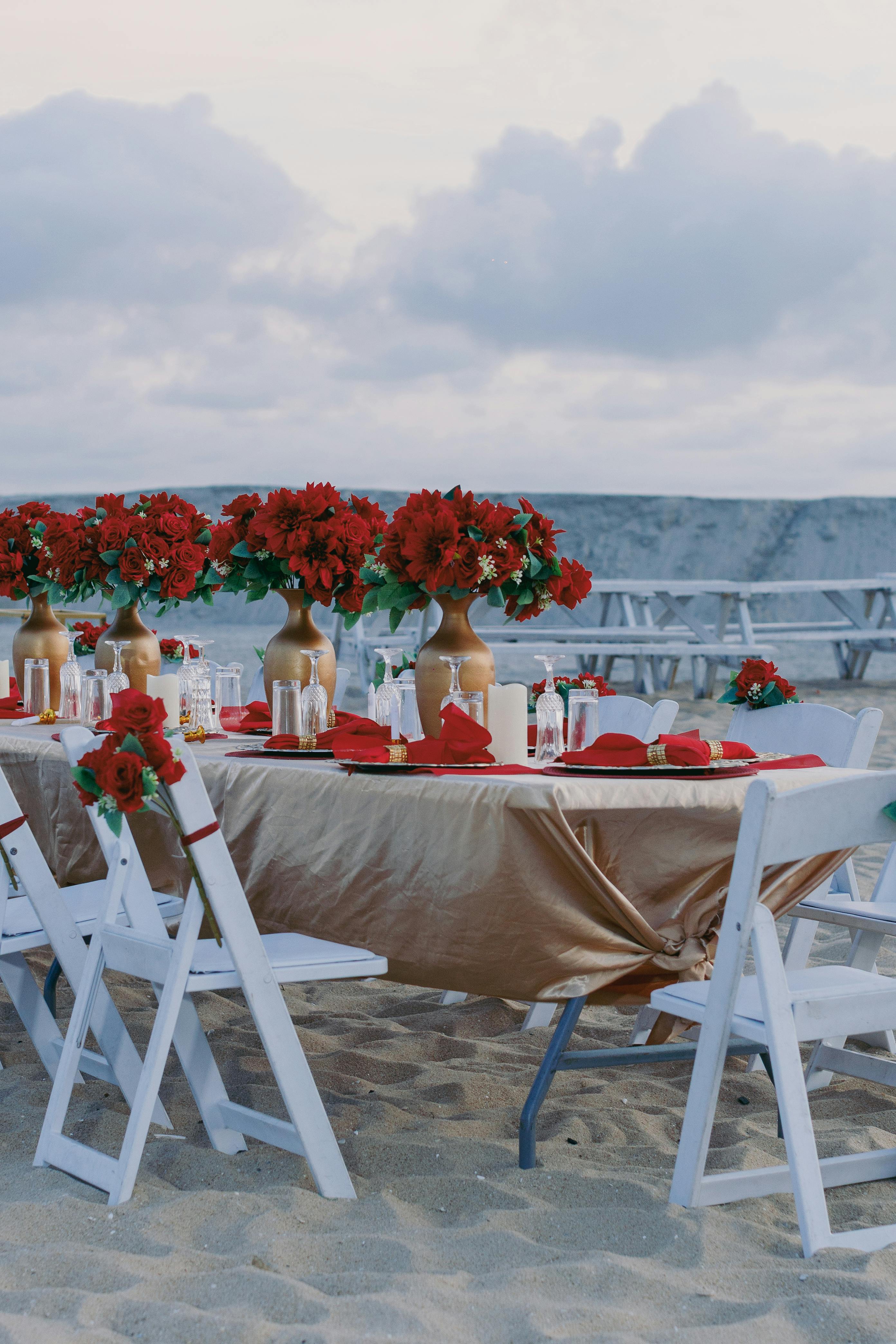 Elegant Beachfront Table Setting with Floral Decor · Free Stock Photo