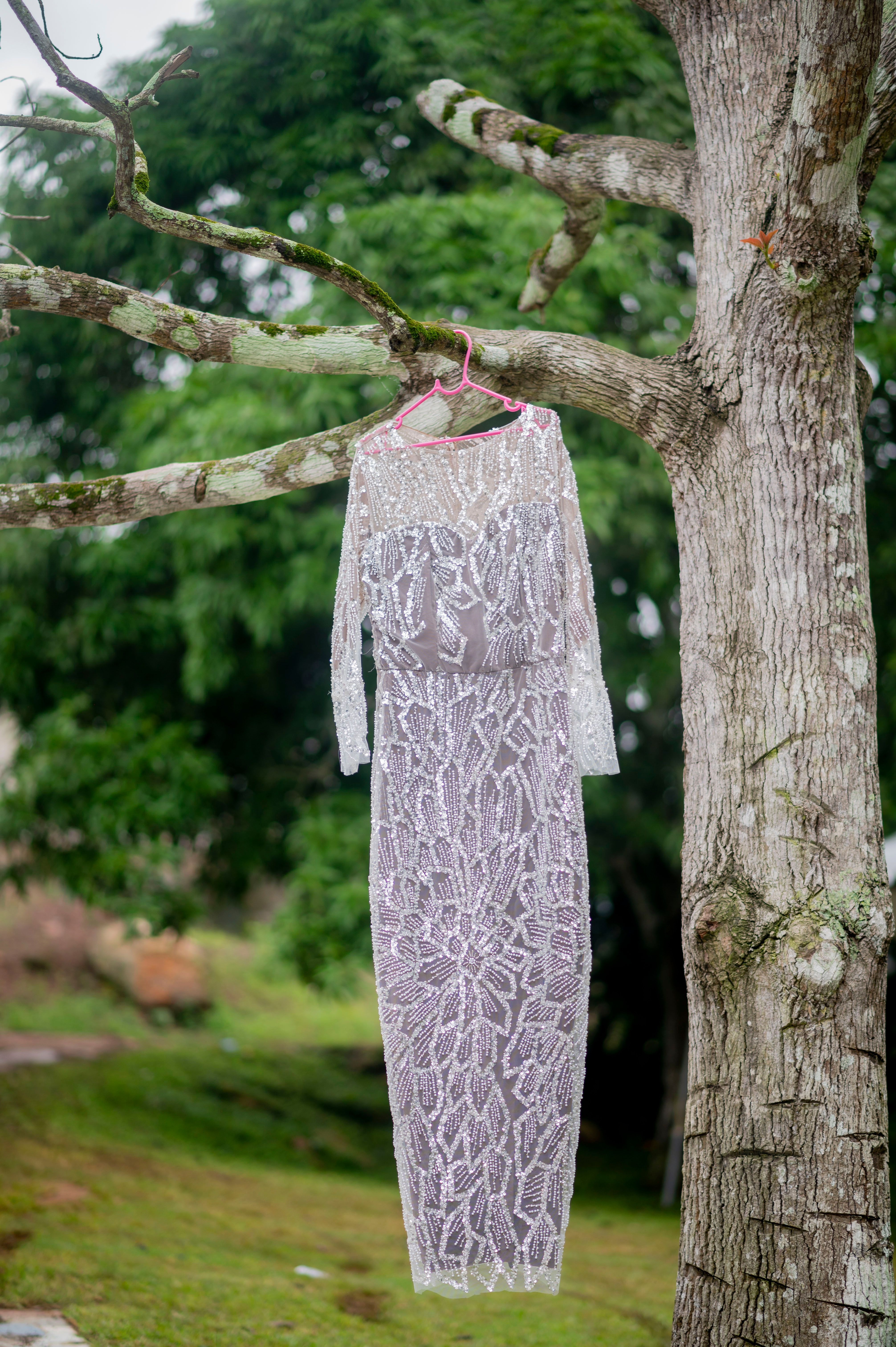 Elegant Lace Dress Hanging Outdoors in Accra · Free Stock Photo
