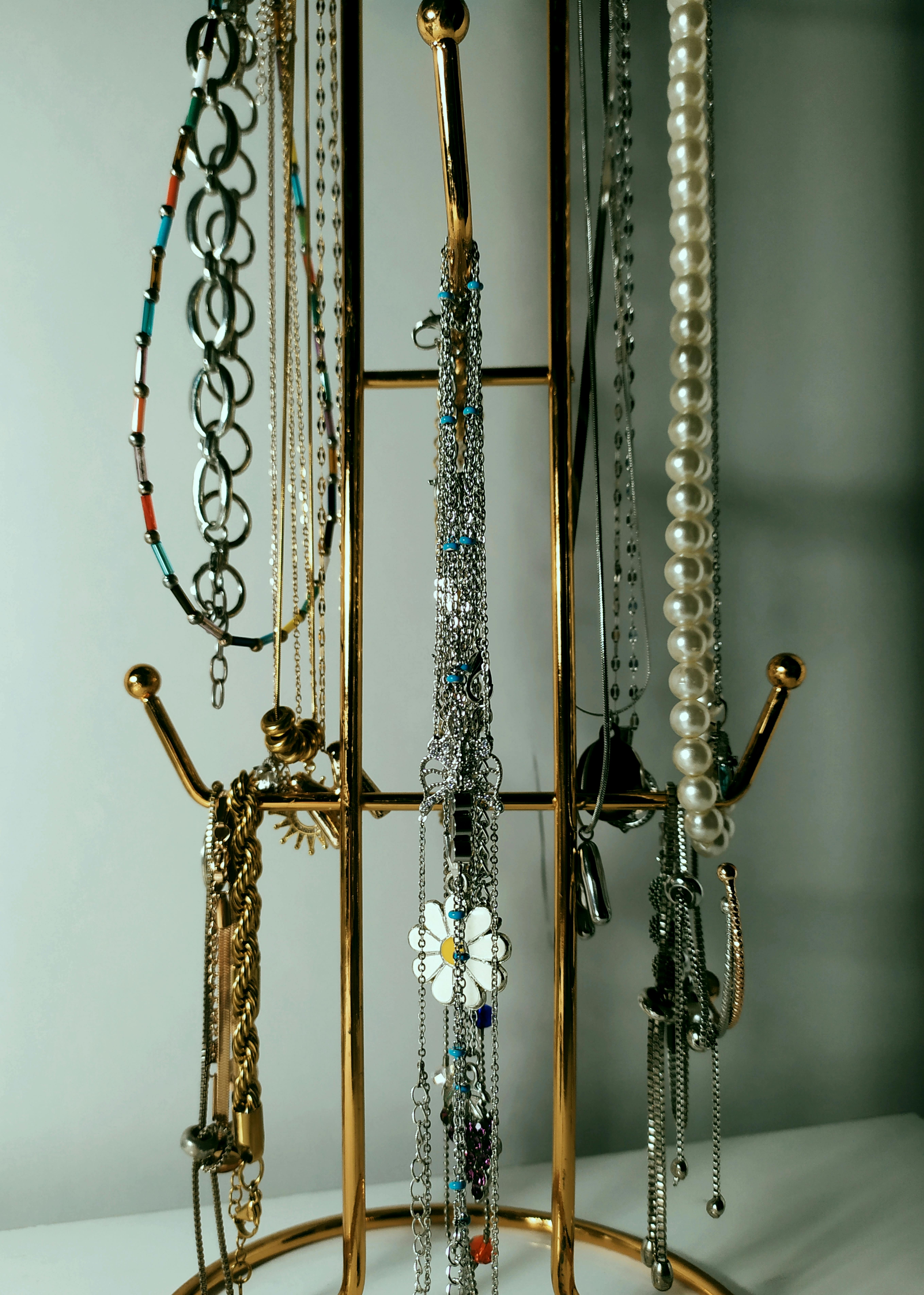 Elegant Jewelry Display on Gold Stand · Free Stock Photo