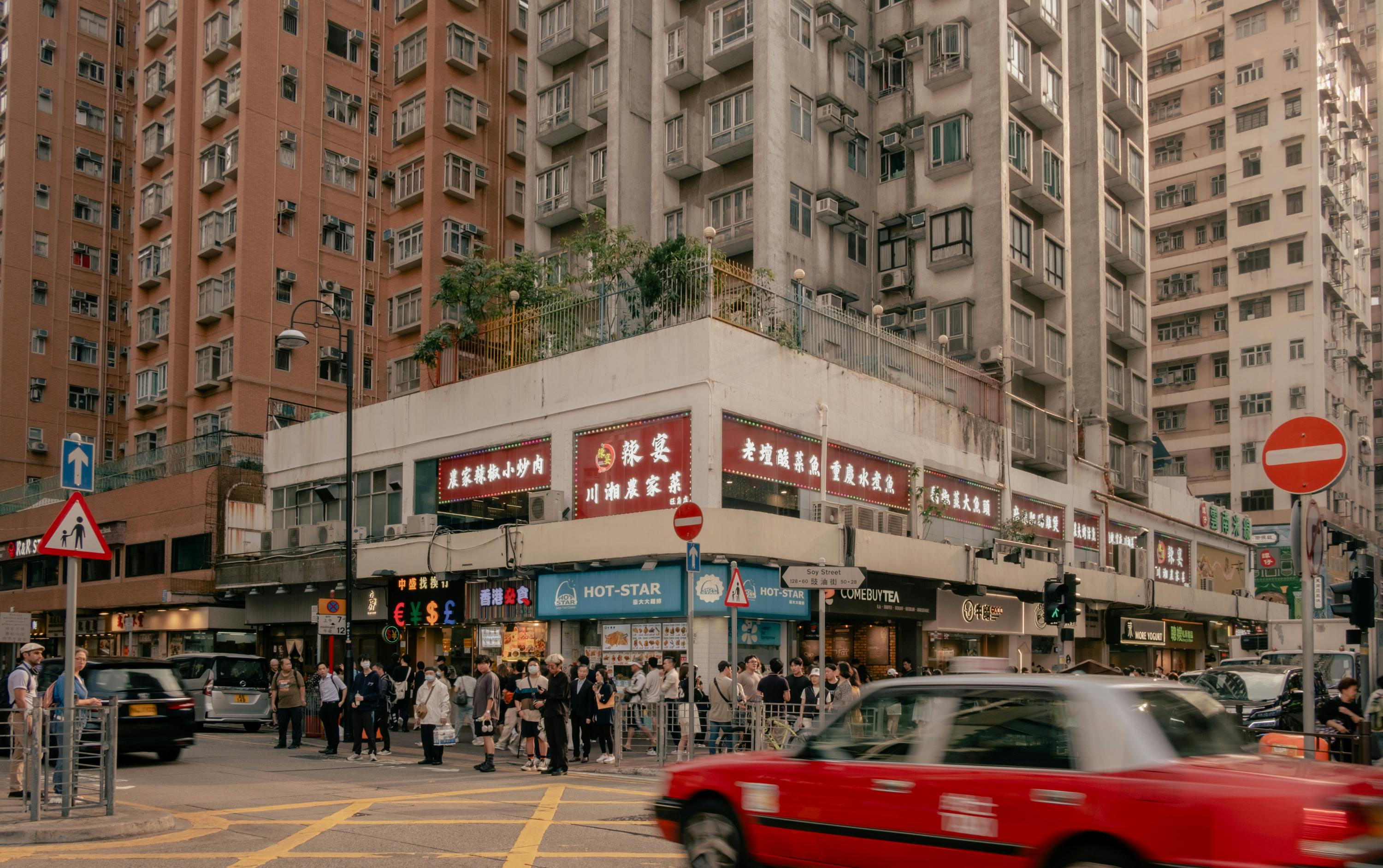 Busy Hong Kong Street Scene with Red Taxi · Free Stock Photo