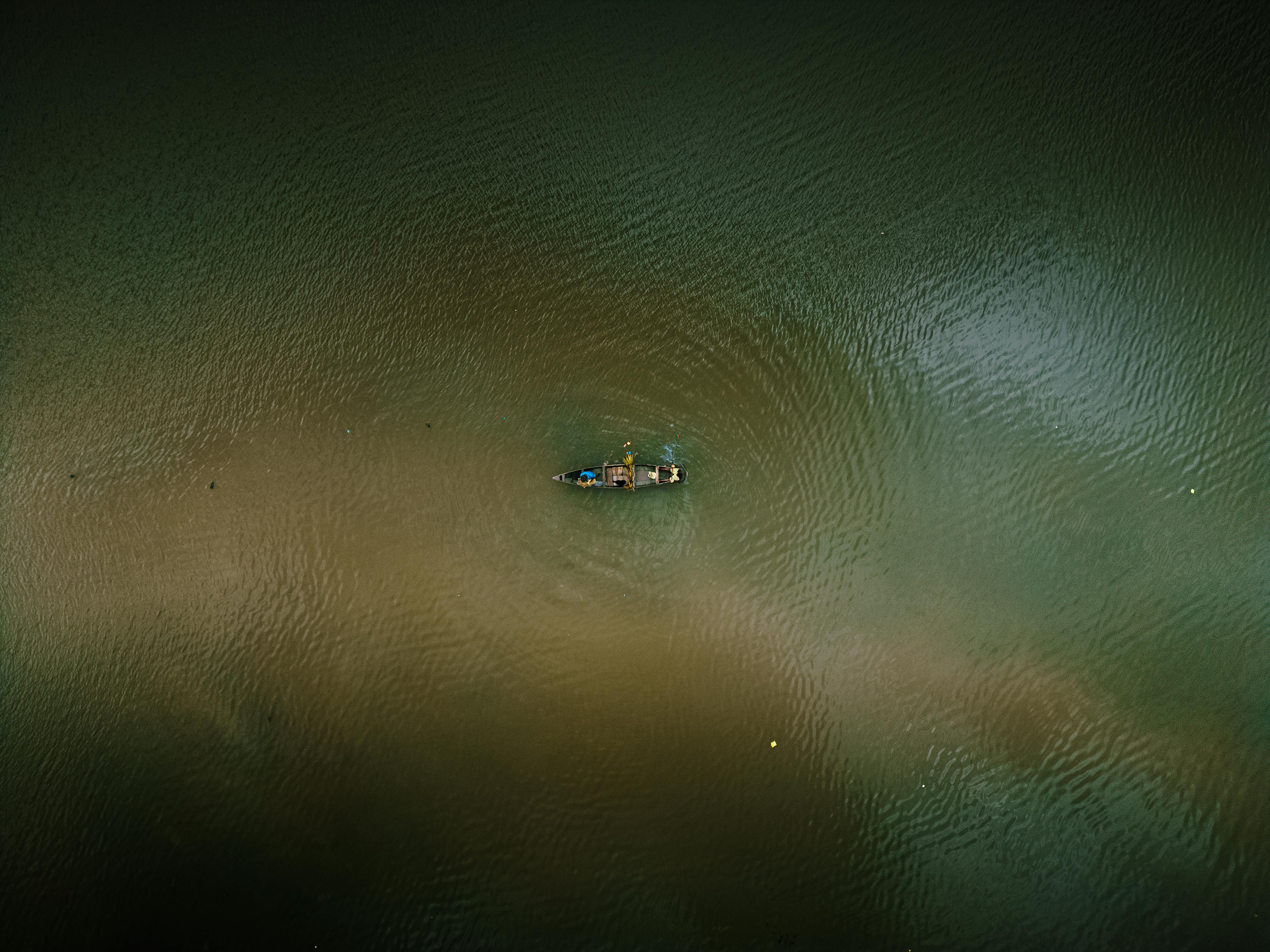 Aerial View of Fisherman Alone in Vast Lake · Free Stock Photo