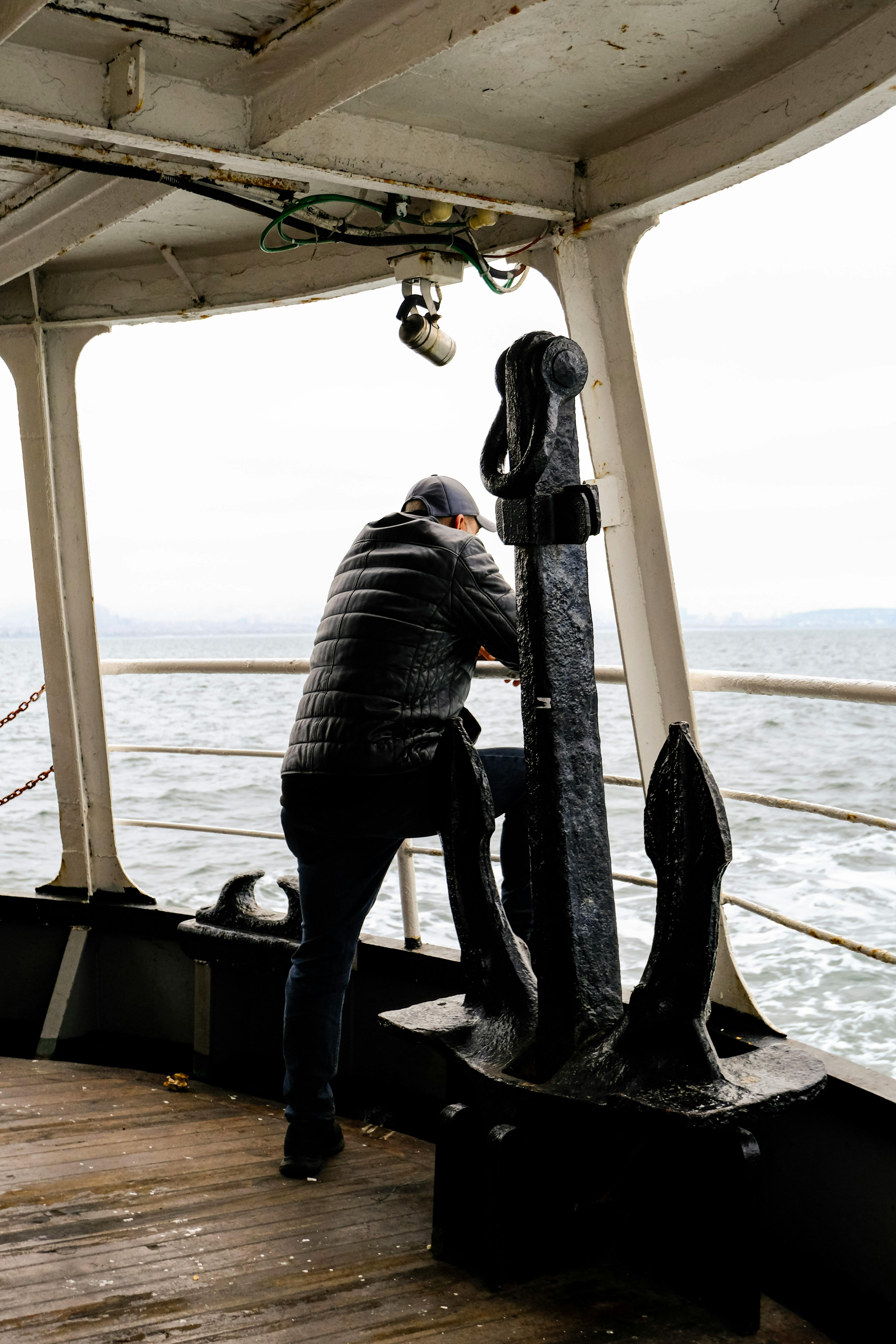 Man Standing on Ship Deck Beside Anchor · Free Stock Photo
